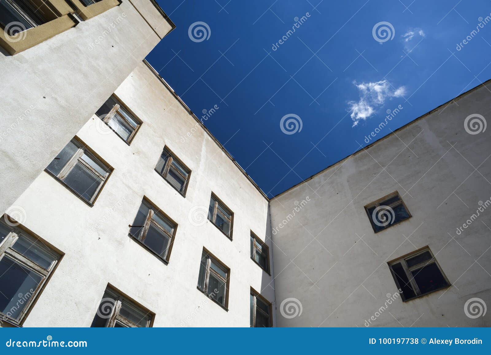 White Building with Square Windows Against Blue Sky Stock Photo - Image ...