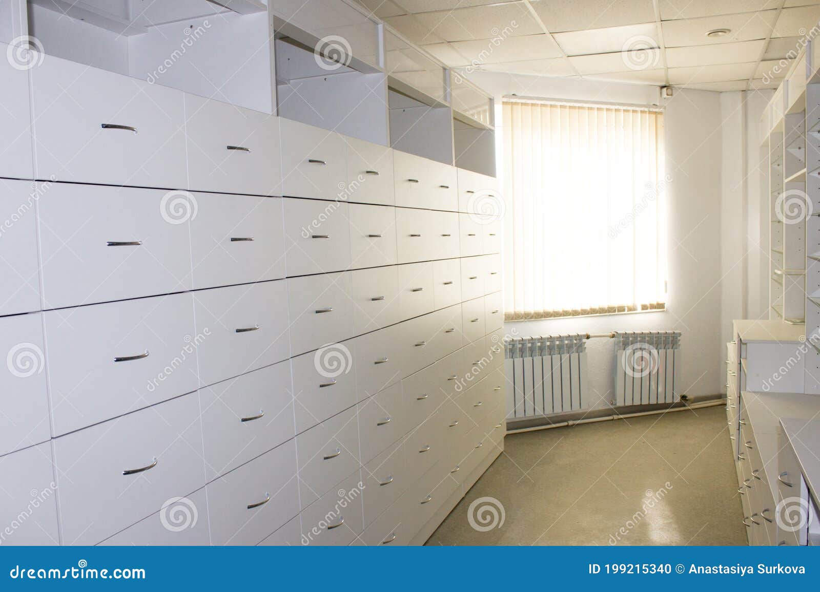 White Cabinets in a Pharmacy or Medical Laboratory. Light Walls and ...