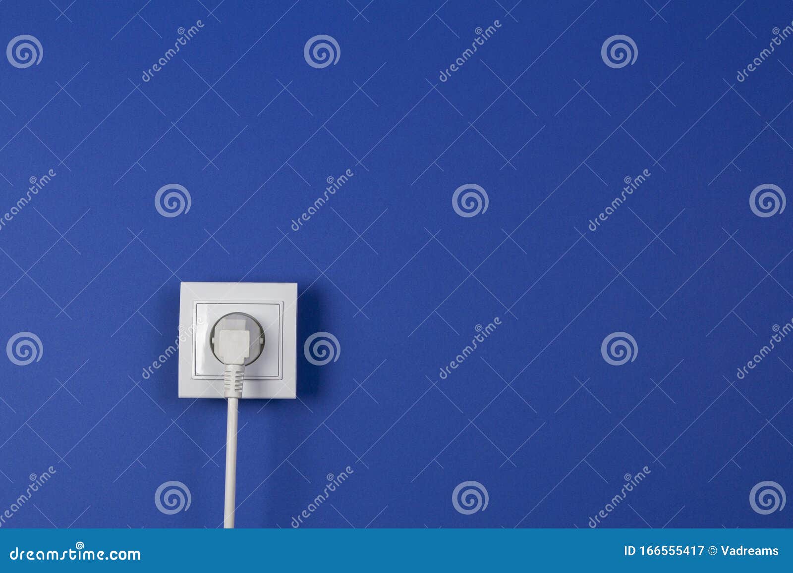 White Cable Plugged into Electrical Socket on Blue Navy Color ...