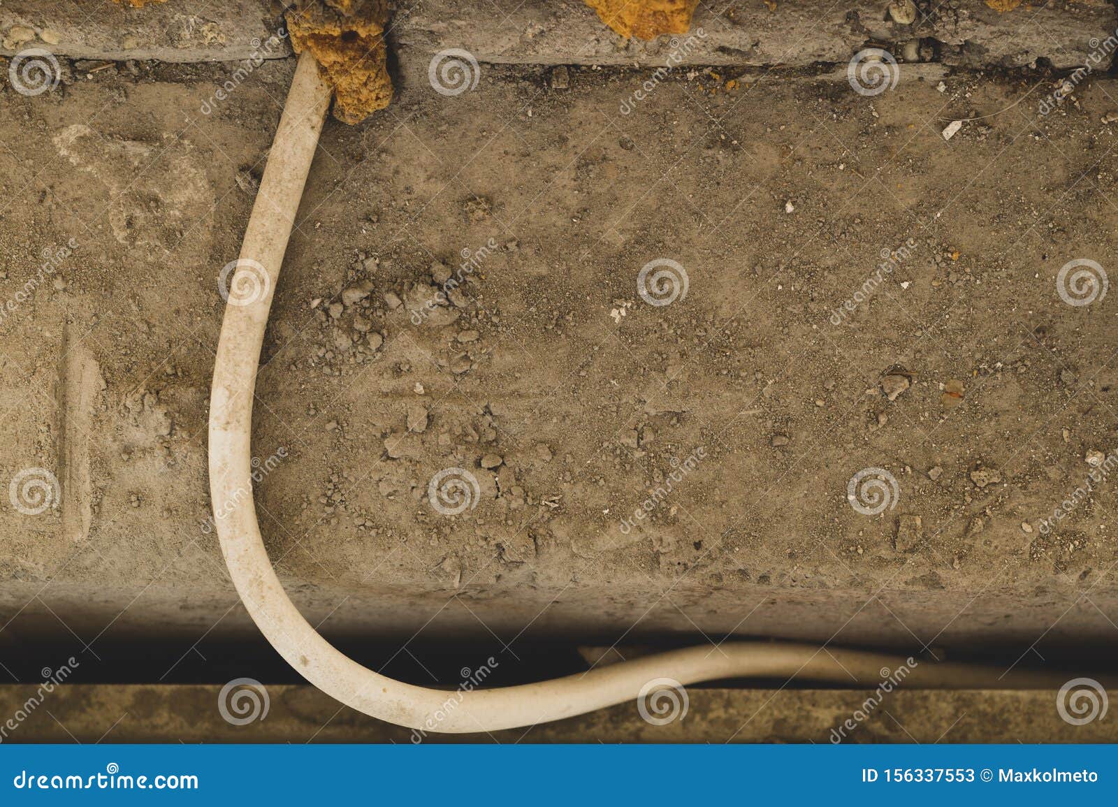 White Cable Sticking Out of the Wall. Cabling Process. Grey Stone ...