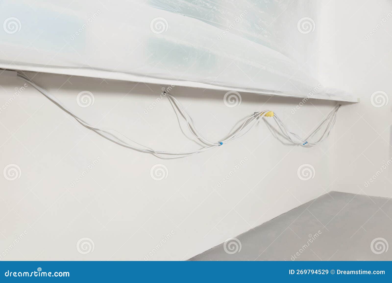 White Cables on Plastered Wall Indoors. Installation of Electrical ...