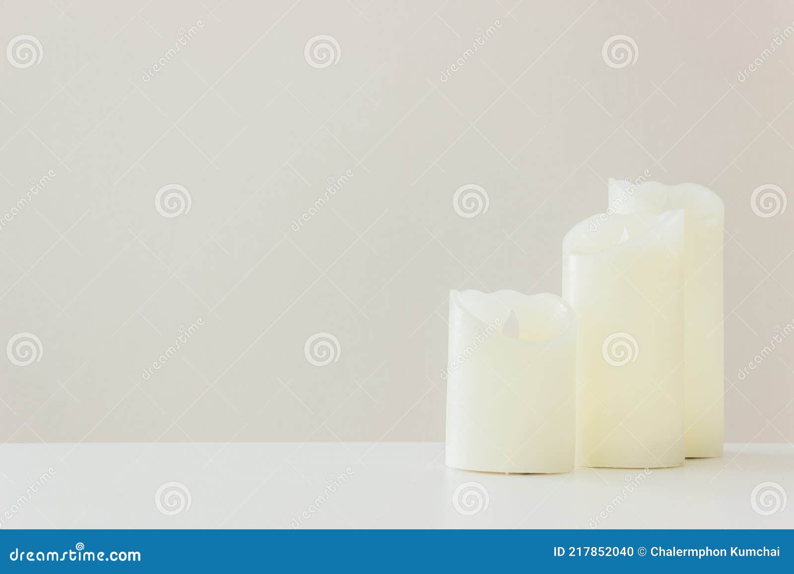A White Candle Light on Table Over the Light Wall. Stock Photo - Image ...
