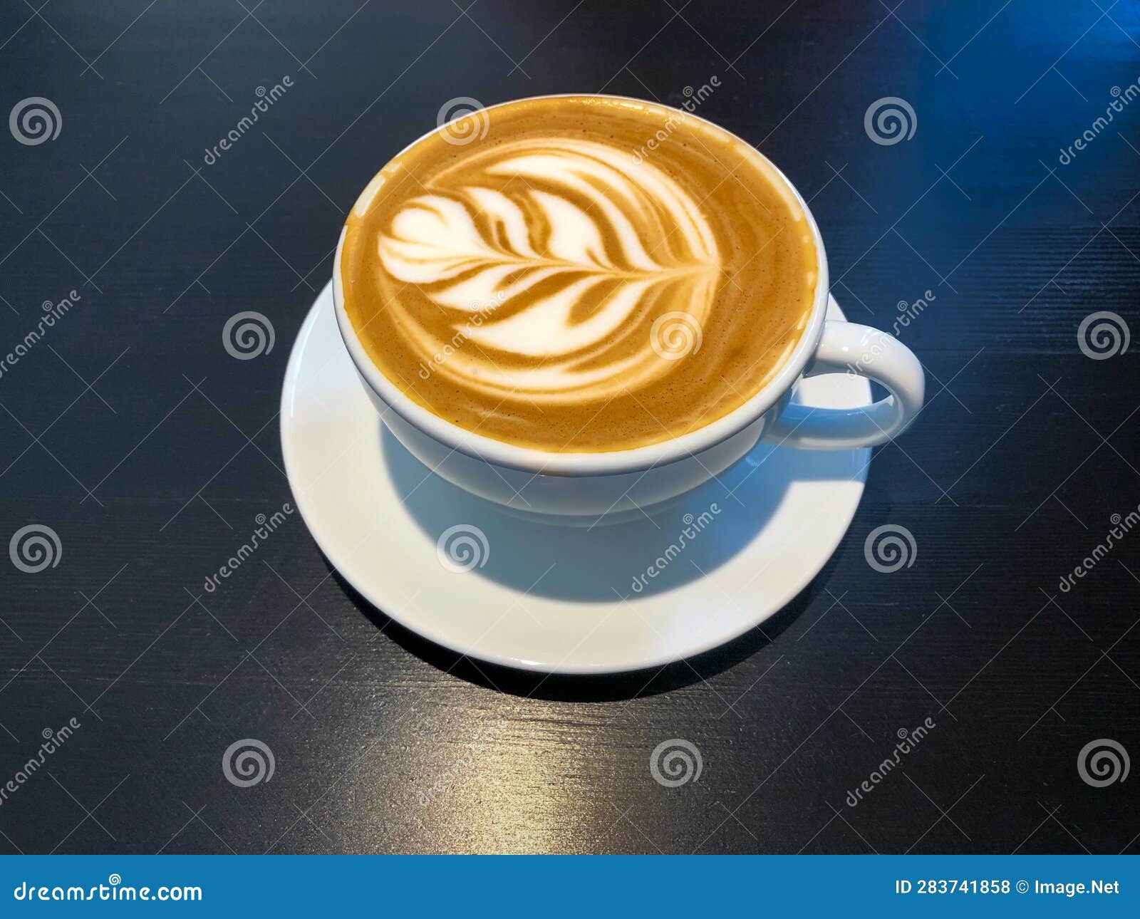 White Cap of Coffee Latte on a Black Desk Surface Stock Photo - Image ...