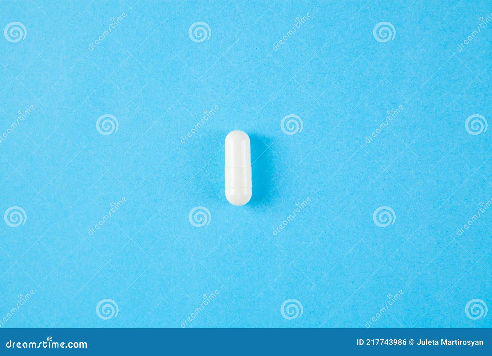 White Capsule on Blue Background Stock Photo - Image of background ...