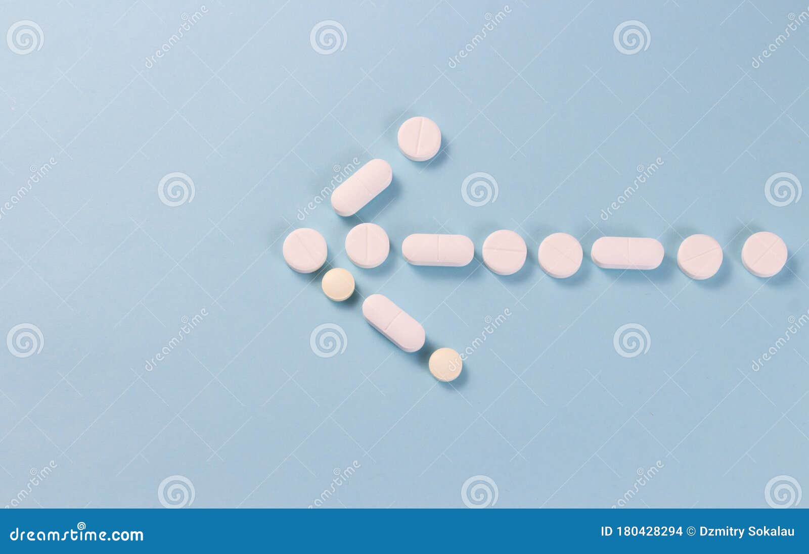 White Capsules in the Shape of an Arrow on a Blue Background Stock ...