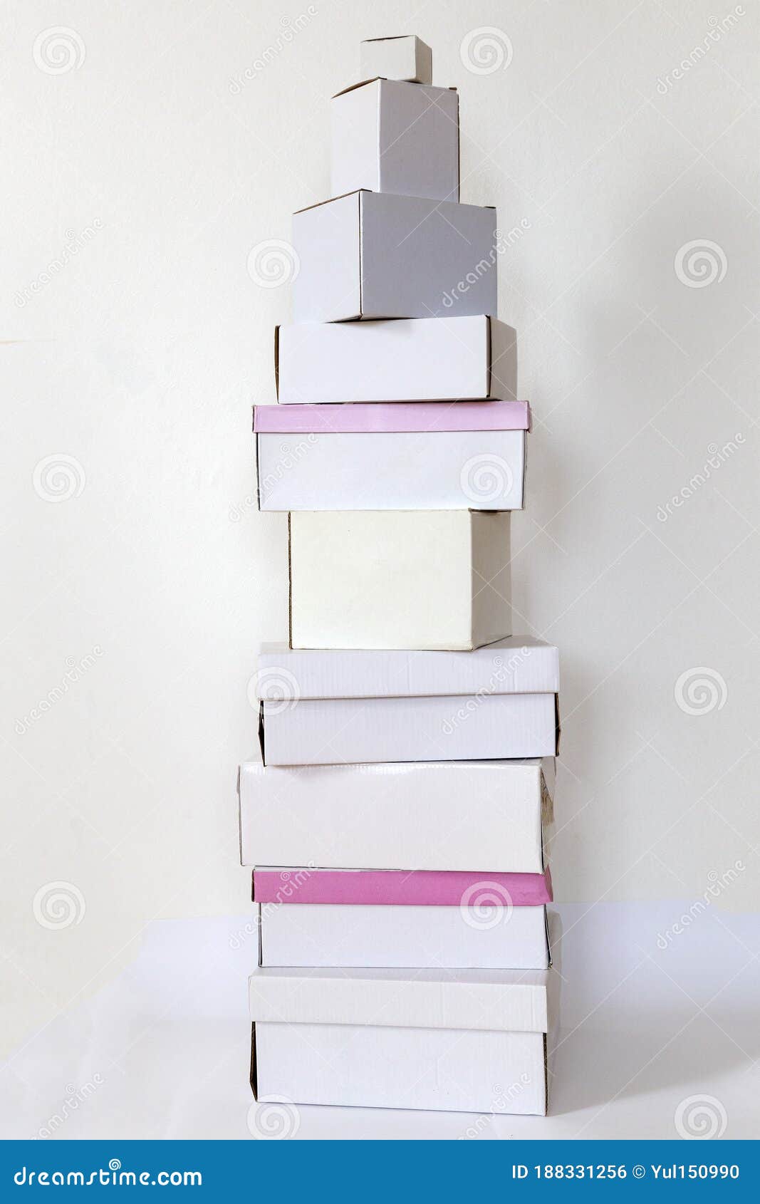 White Carton Boxes of Different Size Standing on Each Other As a High ...