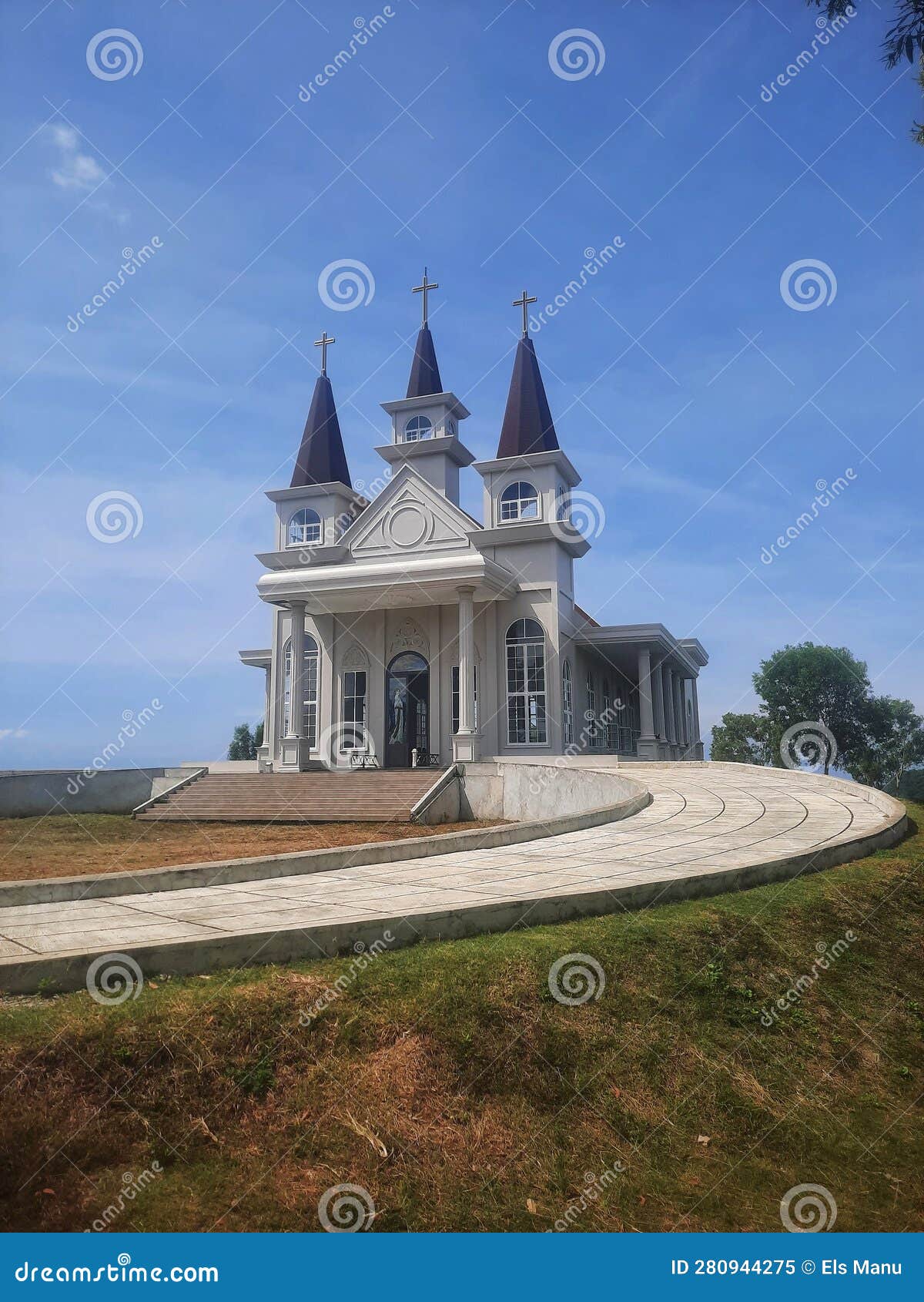 White Catholic Church Against a Bright Blue Sky Background Stock Image ...