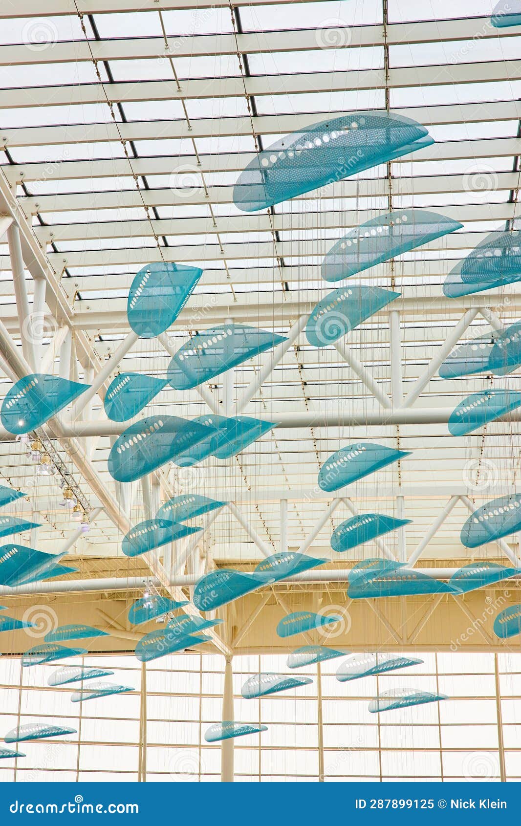 White Ceiling with Hanging Blue Abstract Art in Curved Shells Stock ...