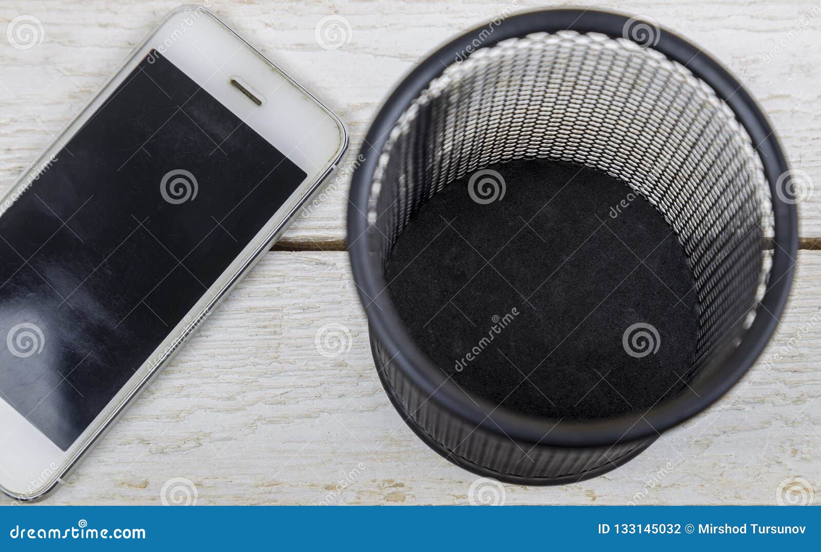 White Cell Phone Near Trash Can, Electronic Waste Concept Stock Photo ...
