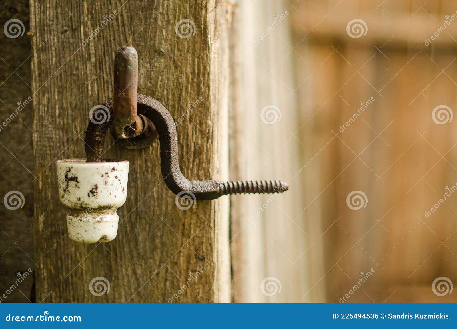White Ceramic Electrical Insulator Hanging on a Hook Stock Photo ...
