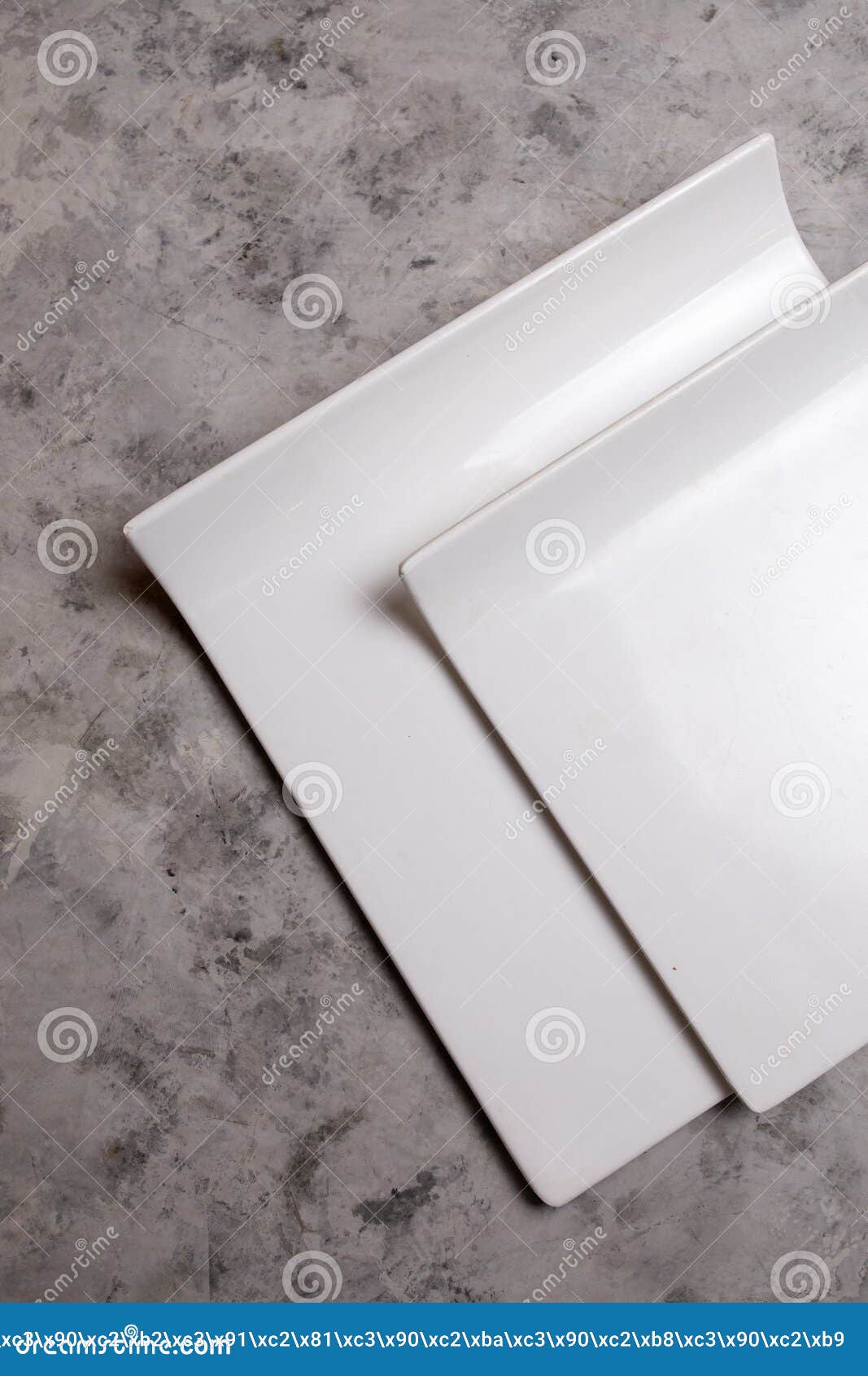 White Ceramic Square Plates on a Concrete Background Stock Photo ...