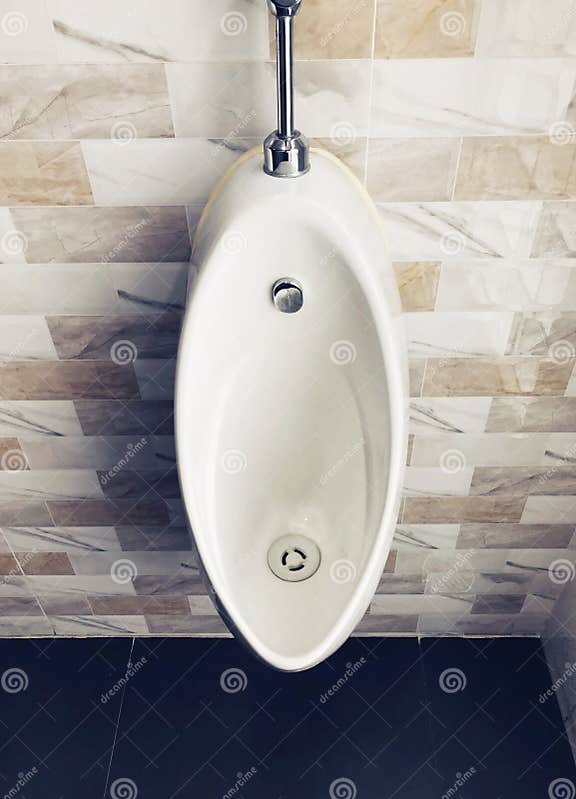 White ceramic urinal stock photo. Image of indoor, tile - 304776248