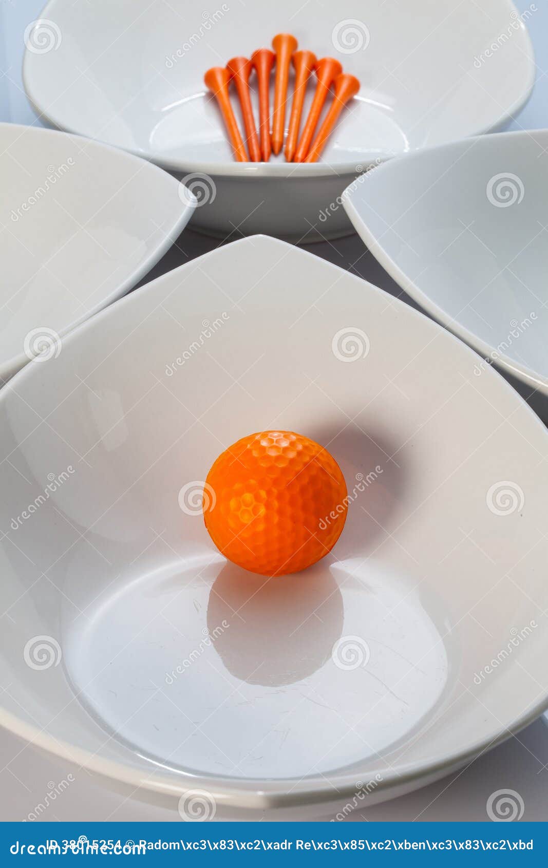 White Ceramics Bowls and Orange Golf Ball Stock Photo - Image of table ...