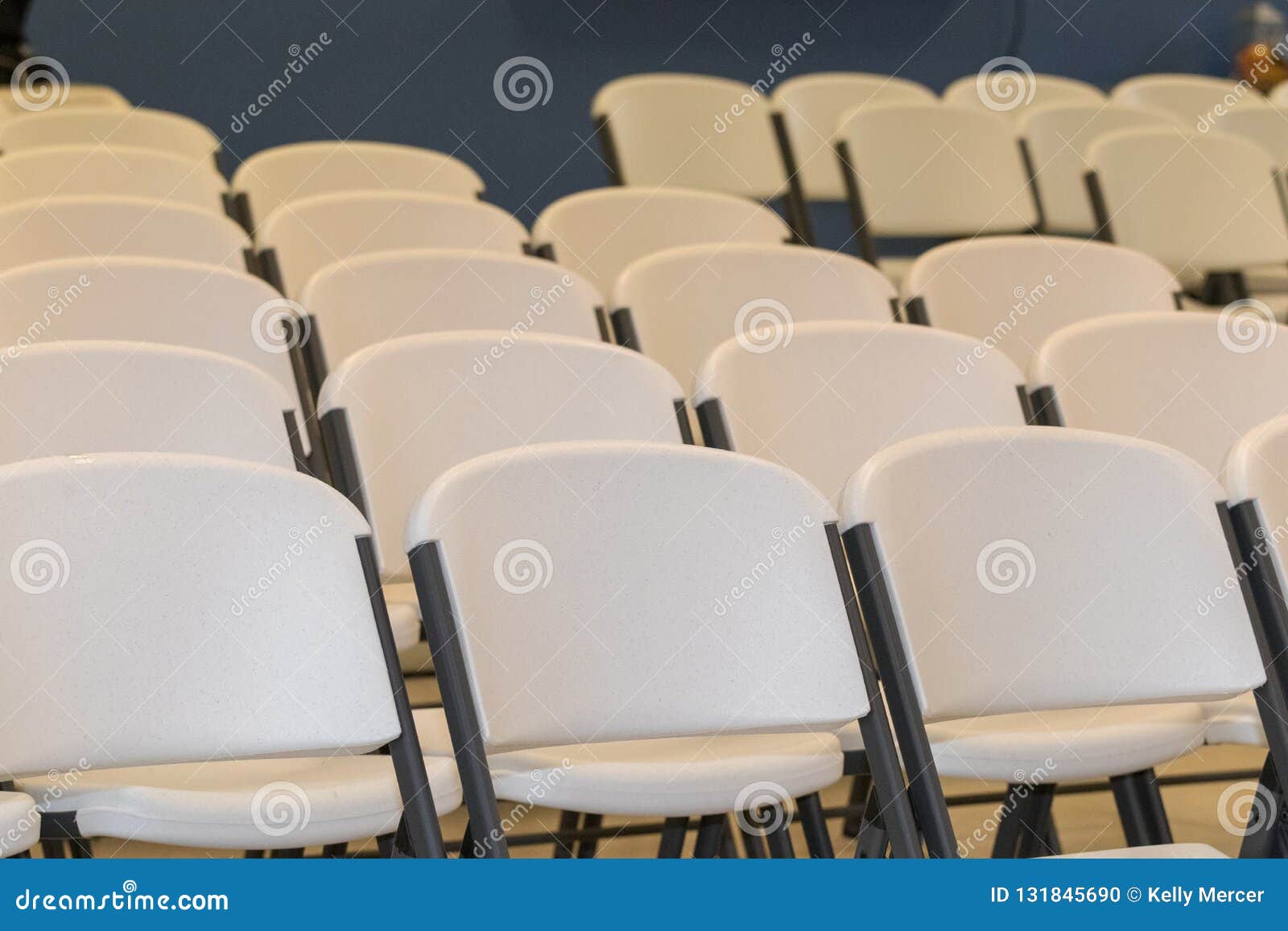 White Chairs in Rows stock photo. Image of folding, hall - 131845690