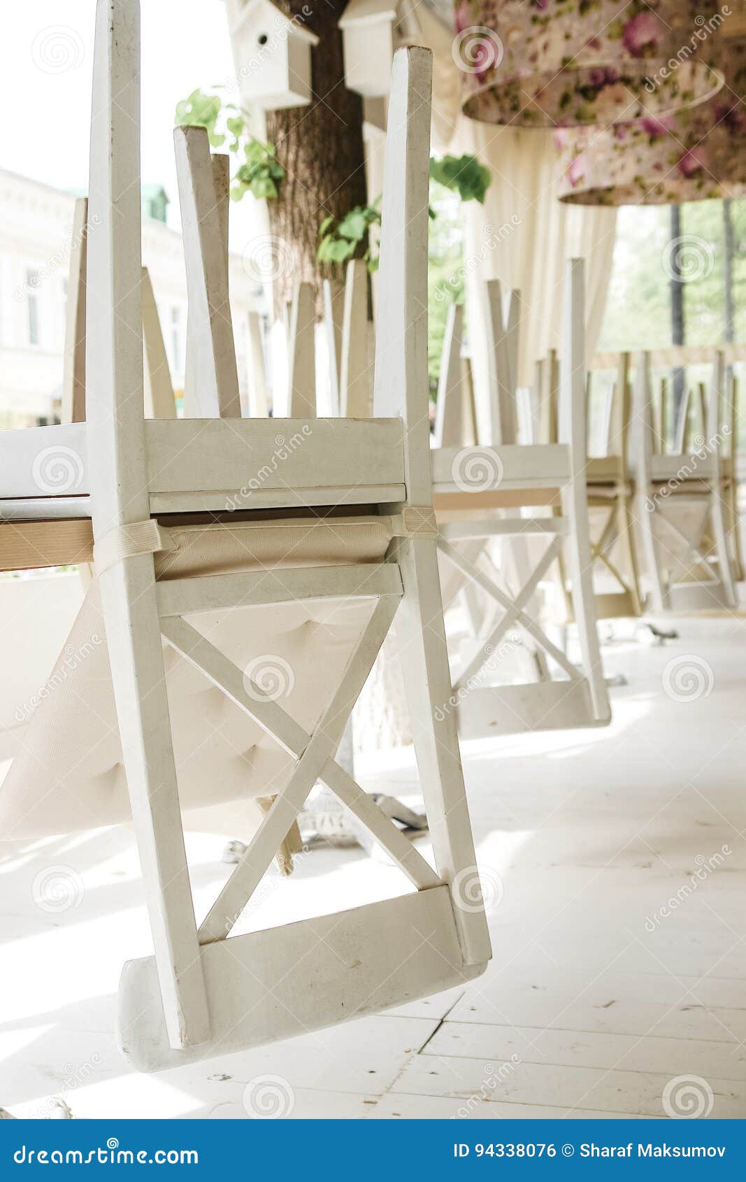 White Chairs on Tables Upside Down on Street Cafe Summer Terrace. Stock ...