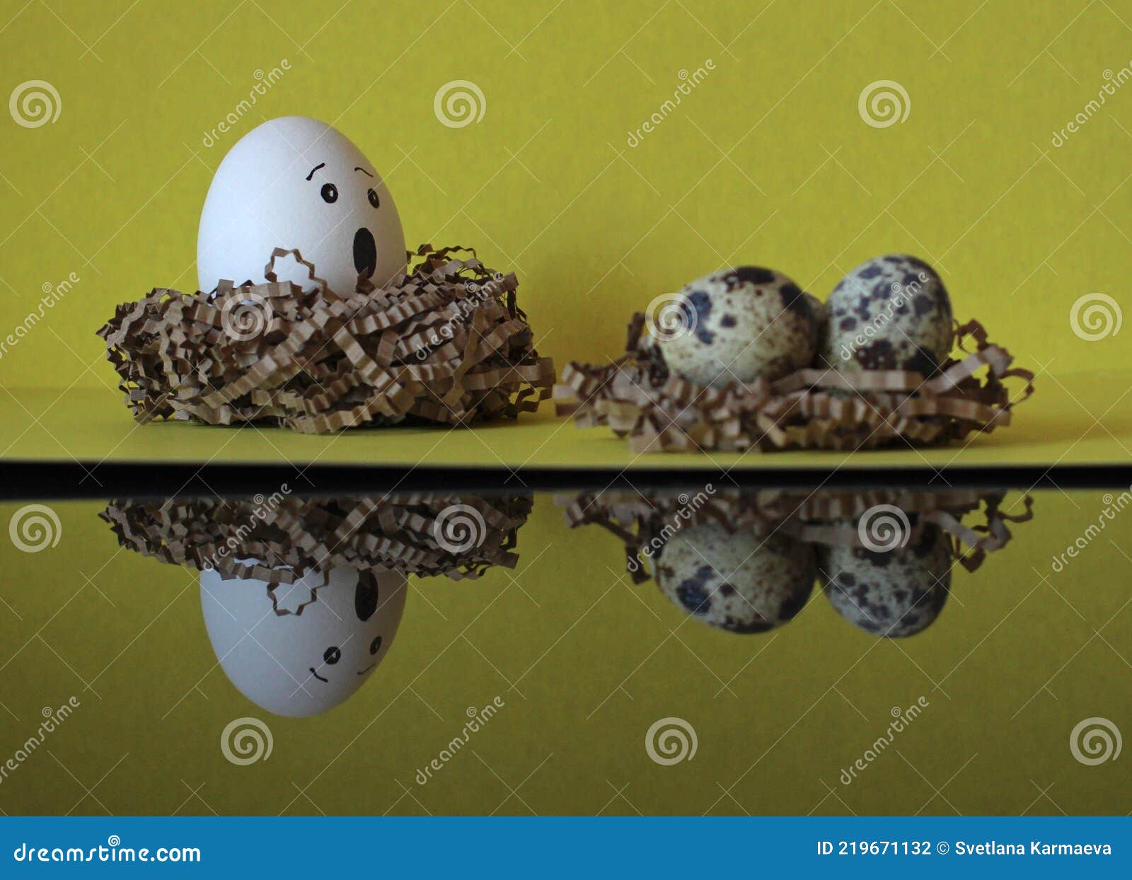 White Chicken Egg with a Surprised Face with Quail Eggs in Nests on a ...