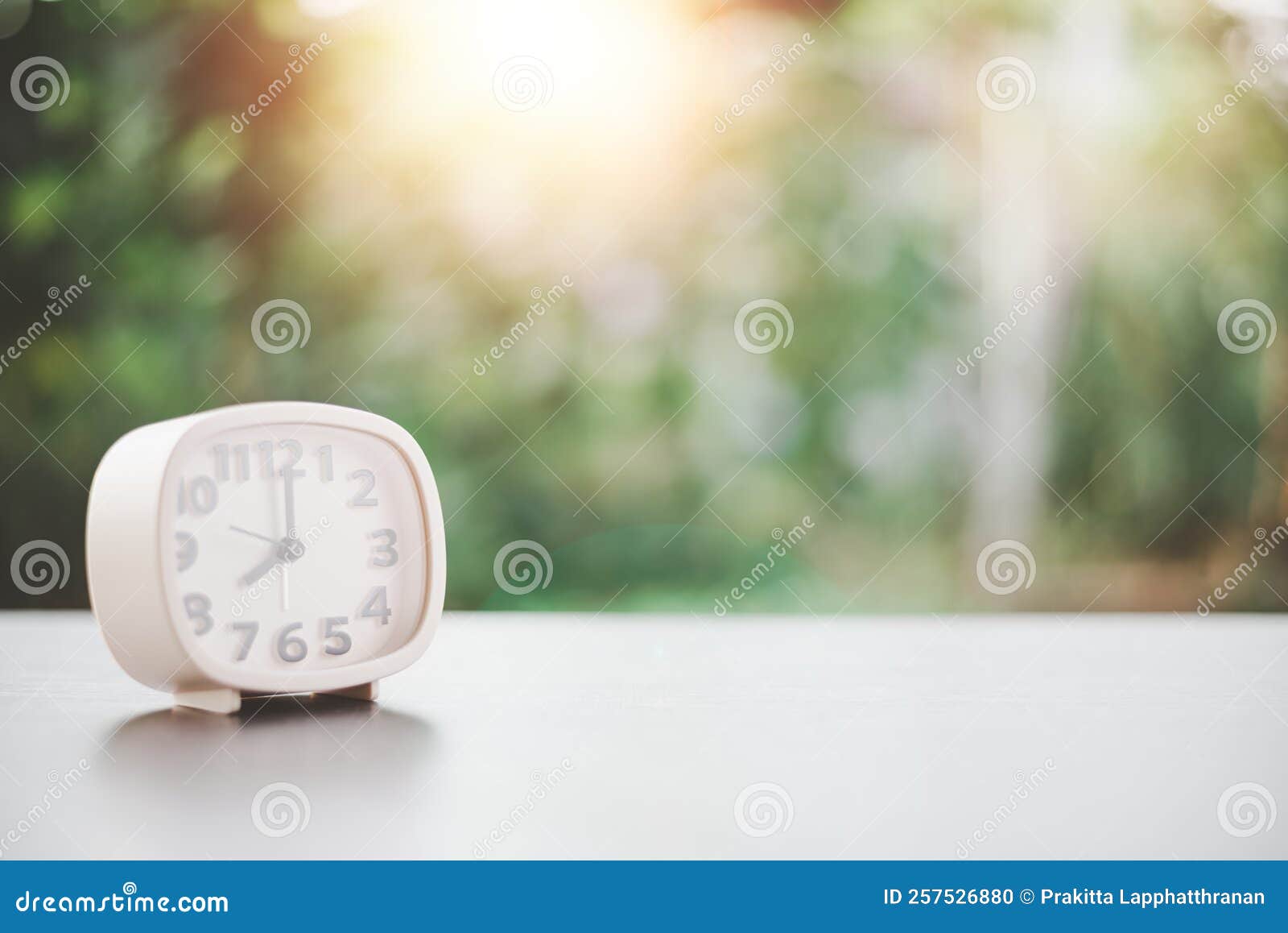 A White Clock is Placed on a Wooden Table, the Concept of Extinction of ...