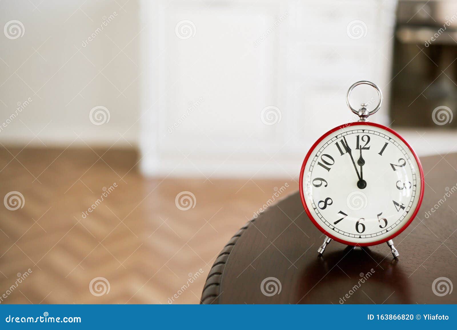 White Clock in a Red Outline Show Time Stands on a Dark Table in the ...