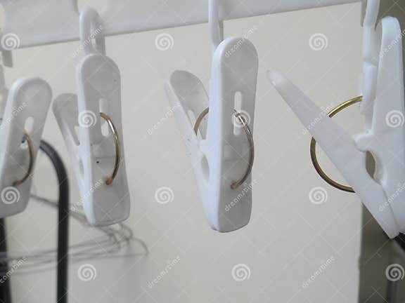 White Cloth Pins Hanging on Drying Rack Stock Photo - Image of clip ...