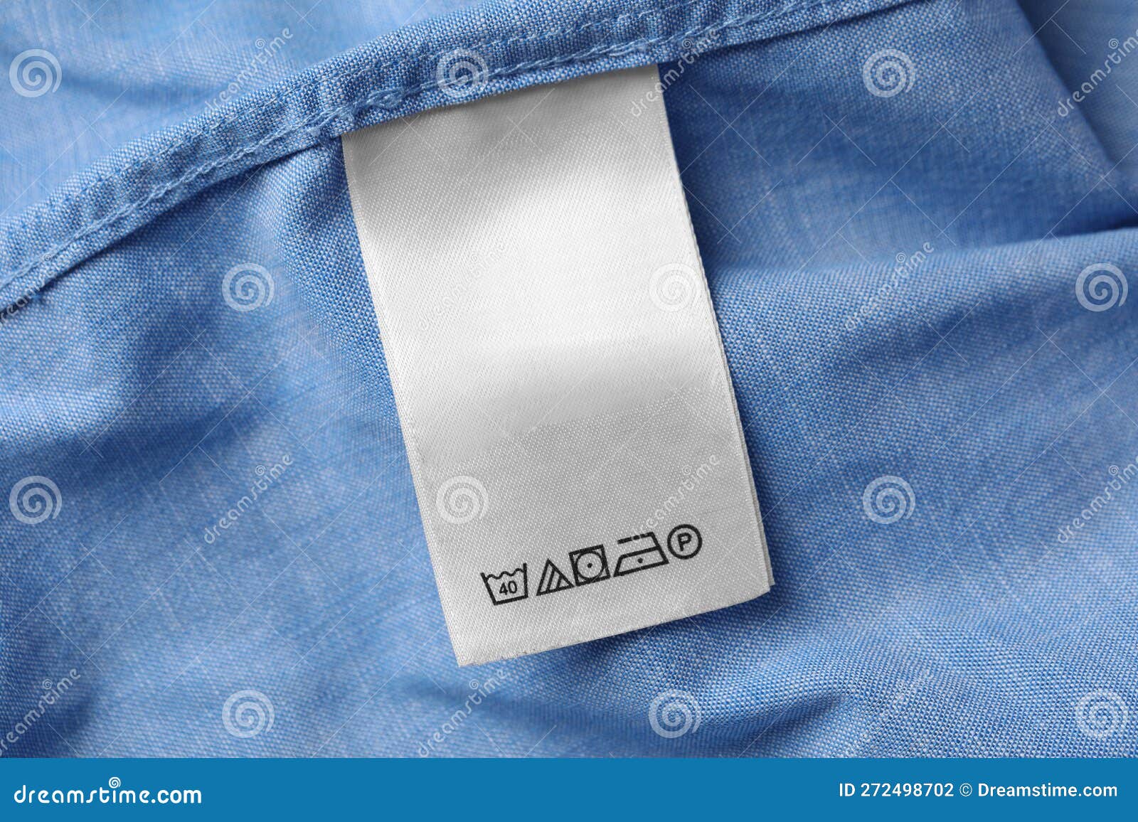 White Clothing Label on Light Blue Garment, Closeup Stock Photo - Image ...