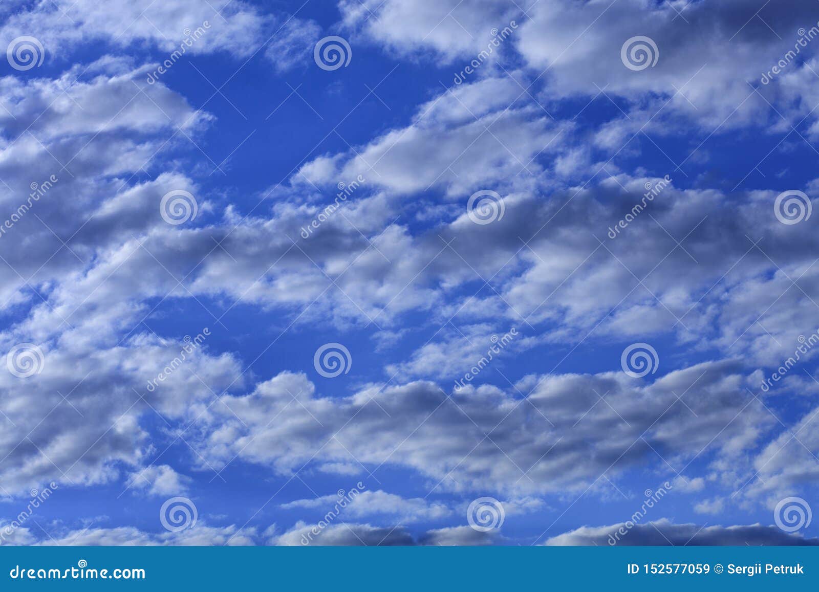 White Clouds Float in a Bright Saturated Blue Sky Stock Image - Image ...