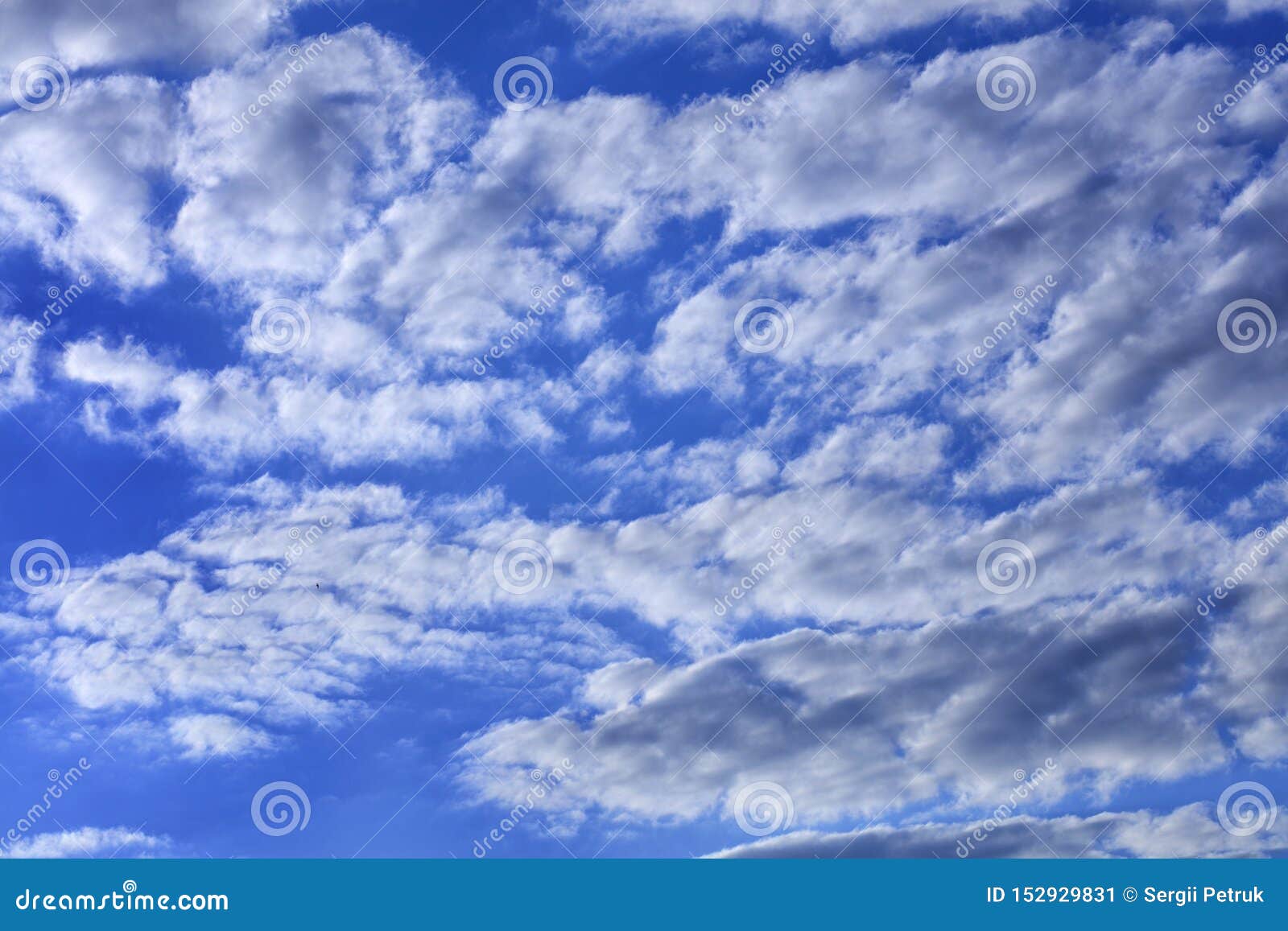 White Clouds Float in a Bright Saturated Blue Sky Stock Image - Image ...