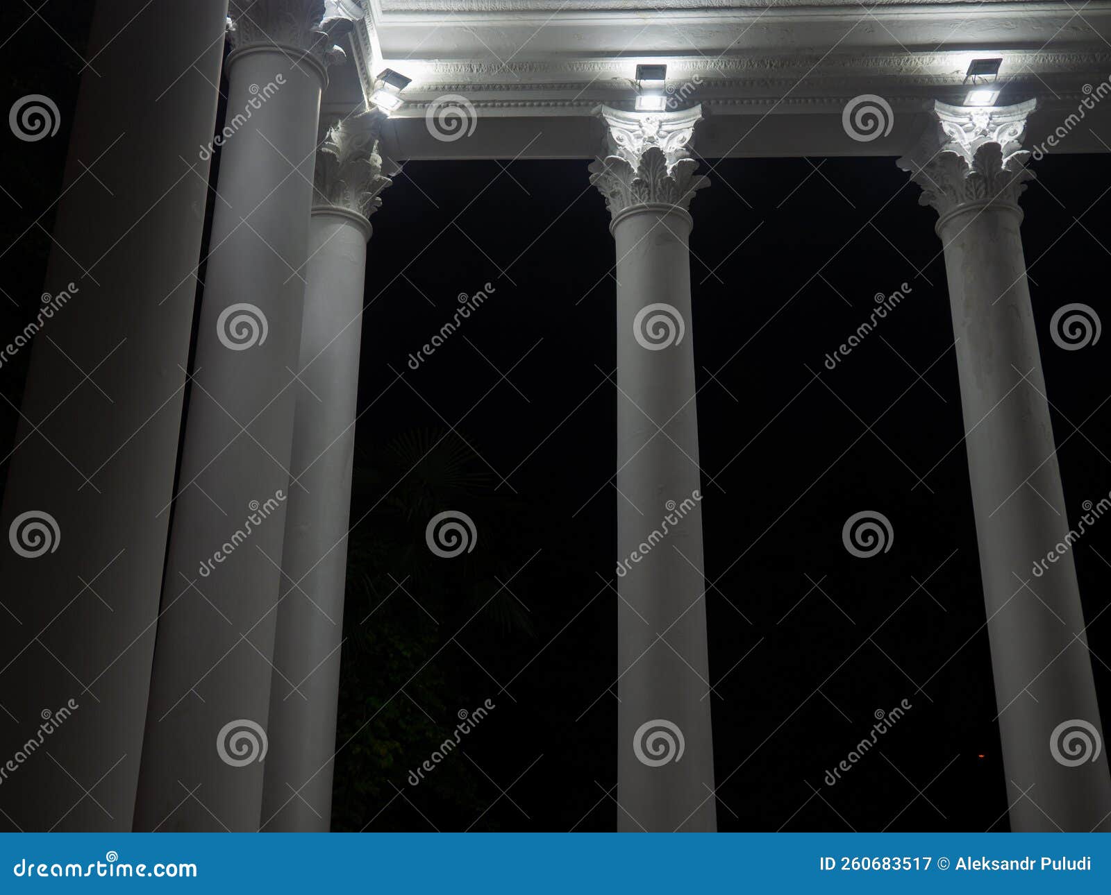 White Colonnade in the Dark. White Columns in the Light of Spotlights ...