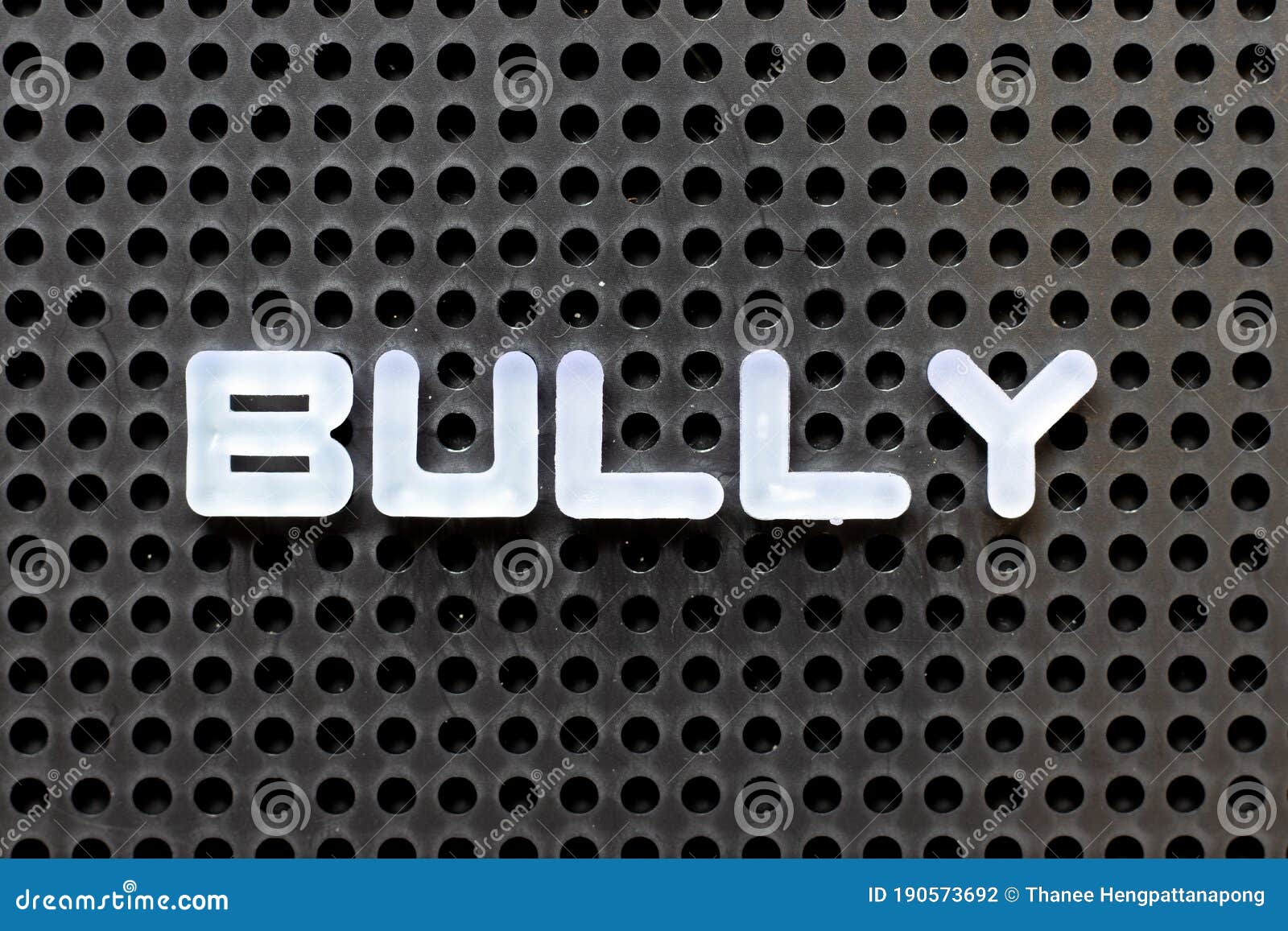 White Alphabet with Word Bully on Black Pegboard Background Stock Photo ...