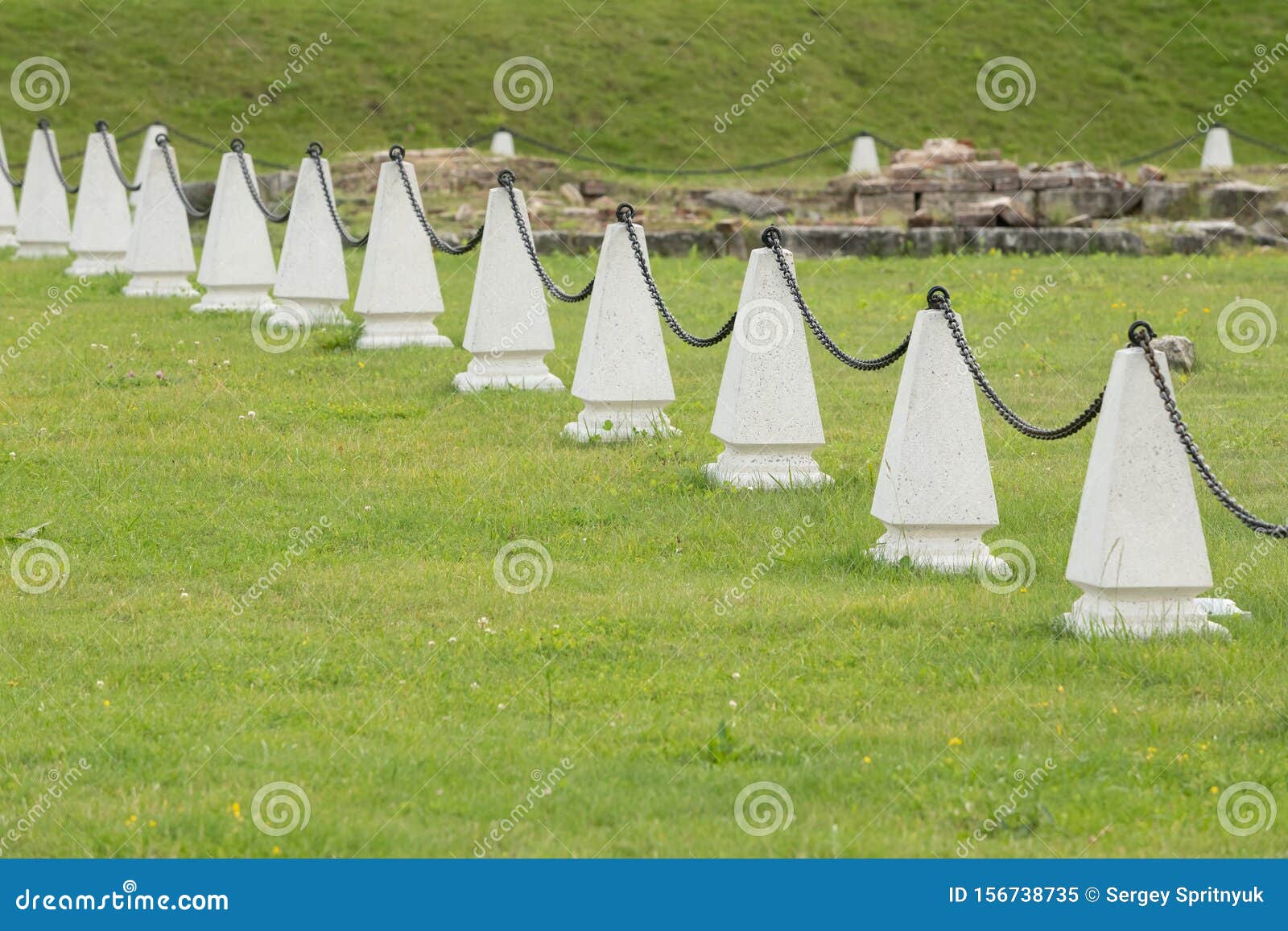 White Concrete Pillars with Black Chain. Fencing of the Protected ...
