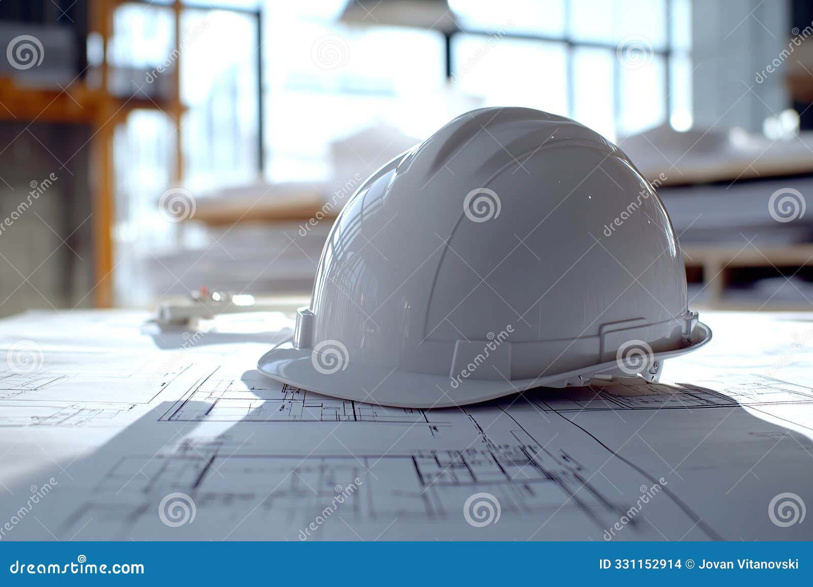White Construction Helmet Resting on Architectural Blueprints in ...