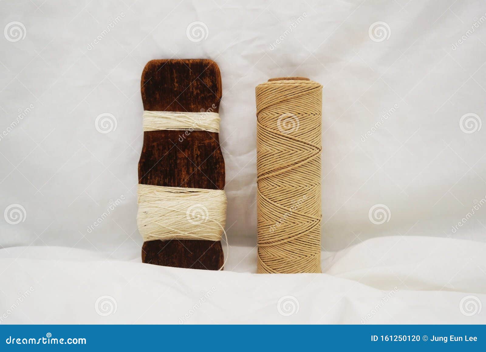 Standing Brown Spool and Rolled Thick Thread in the White Cotton ...