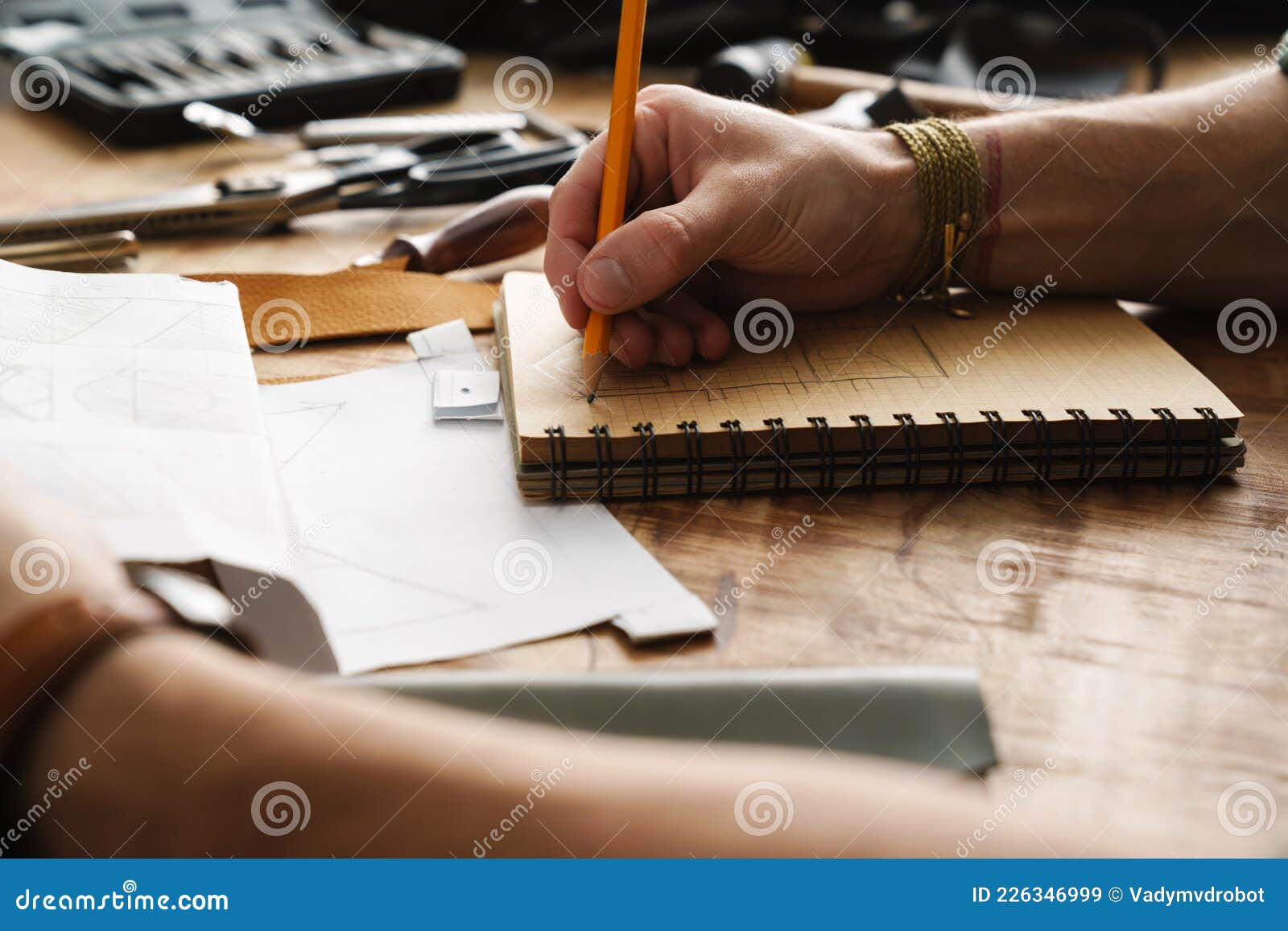 White Craftsman Drawing while Working with Leather Stock Image - Image ...