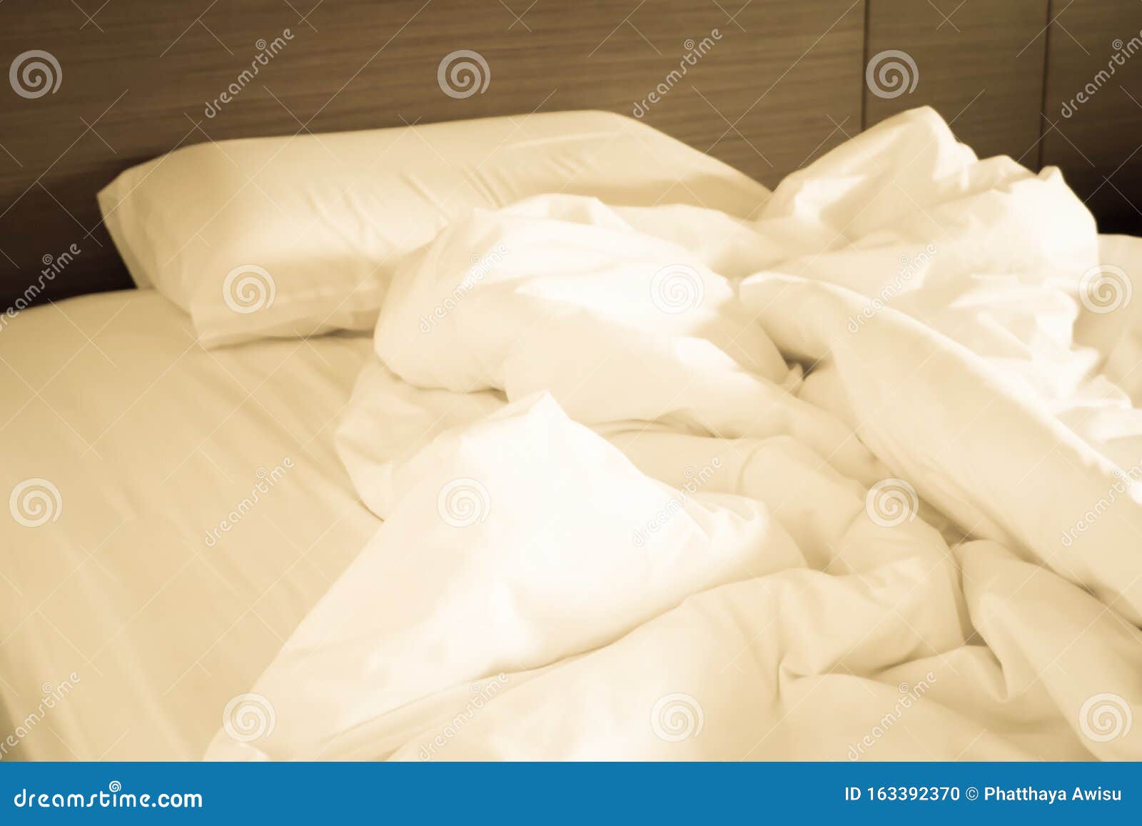 White Crumpled Bed Sheet and Messy Pillows in a Hotel Room Stock Photo ...