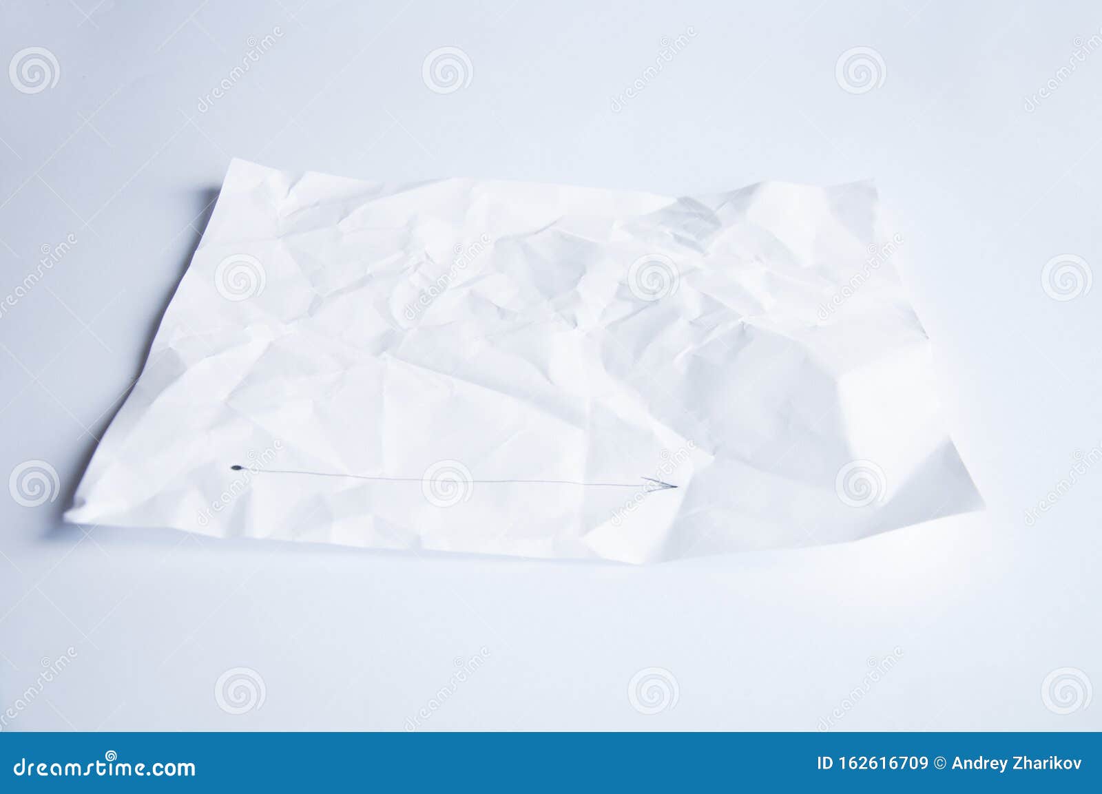 White Crumpled Sheet of Paper Lies on a Table on a White Background. on ...