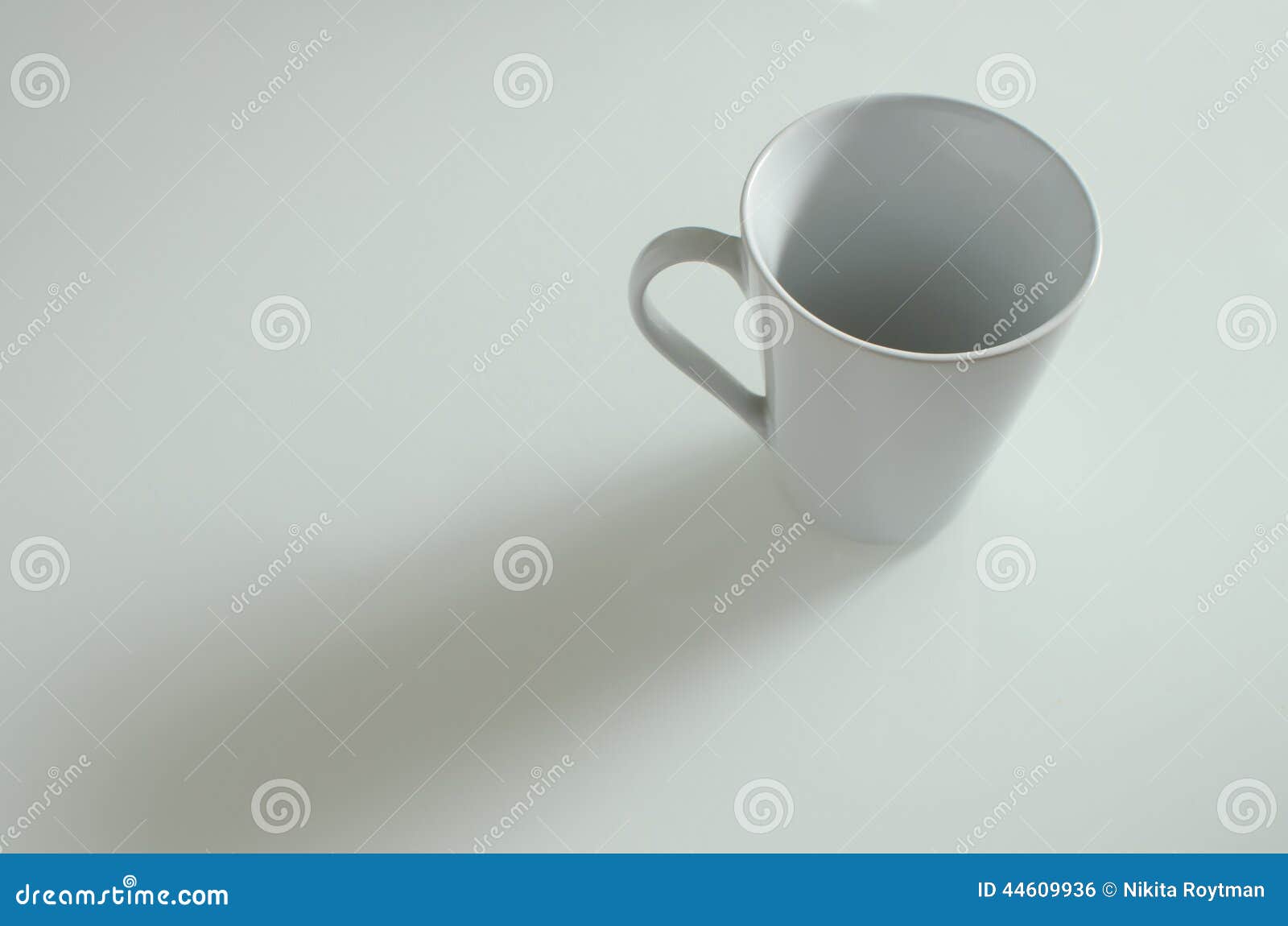 White Cup Casting a Long Shadow Stock Photo - Image of shadow, tonality ...