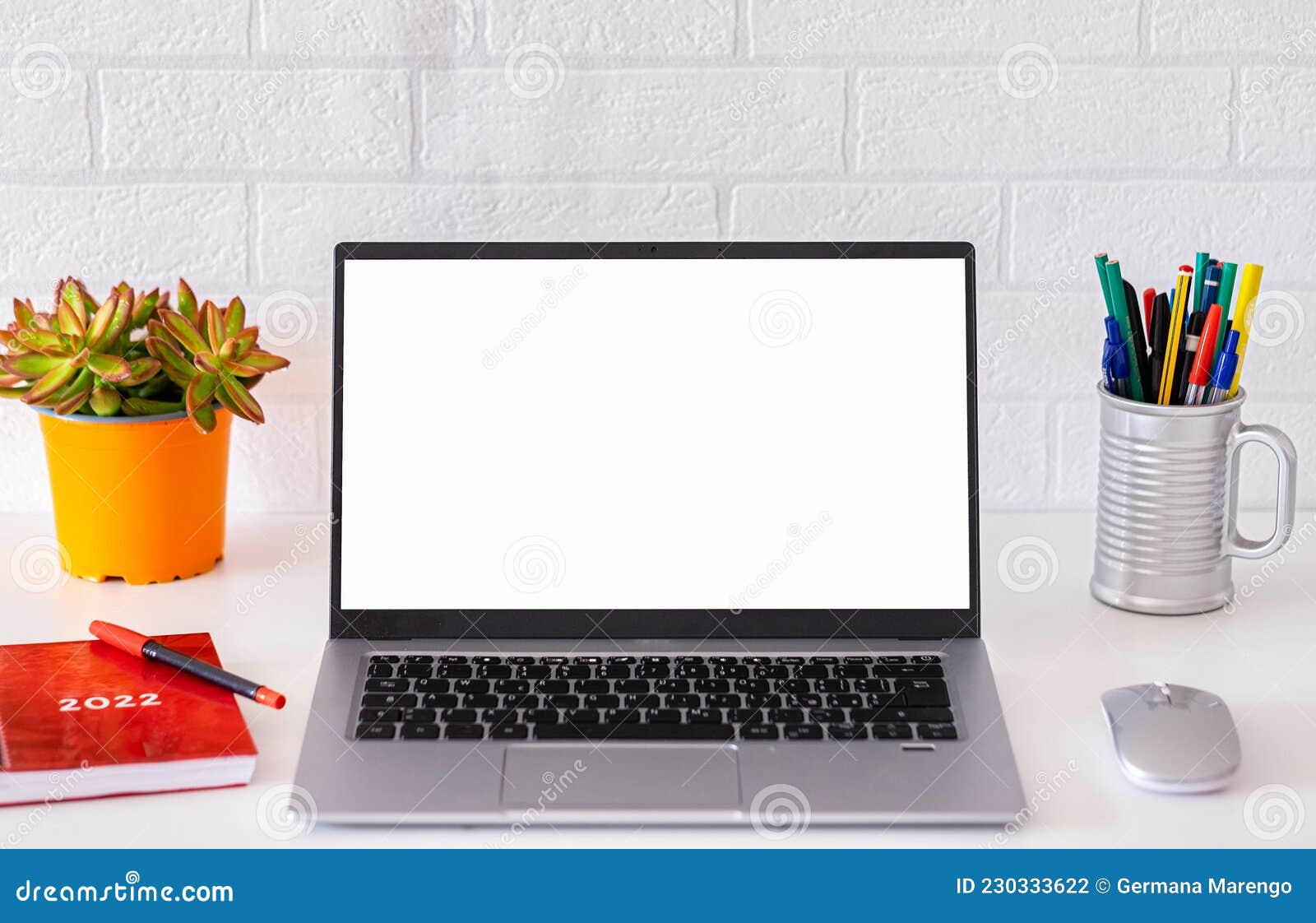 White Desktop and Brick Wall with Organizer, Laptop Computer and Mouse ...