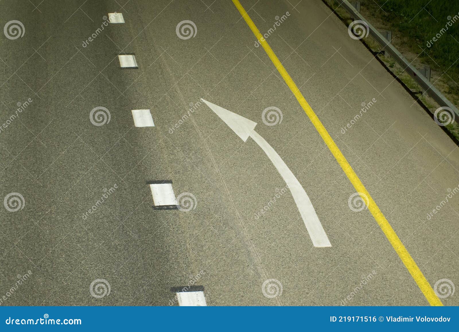 A White Direction Arrow is Drawn on the Asphalt, between a Broken Line ...