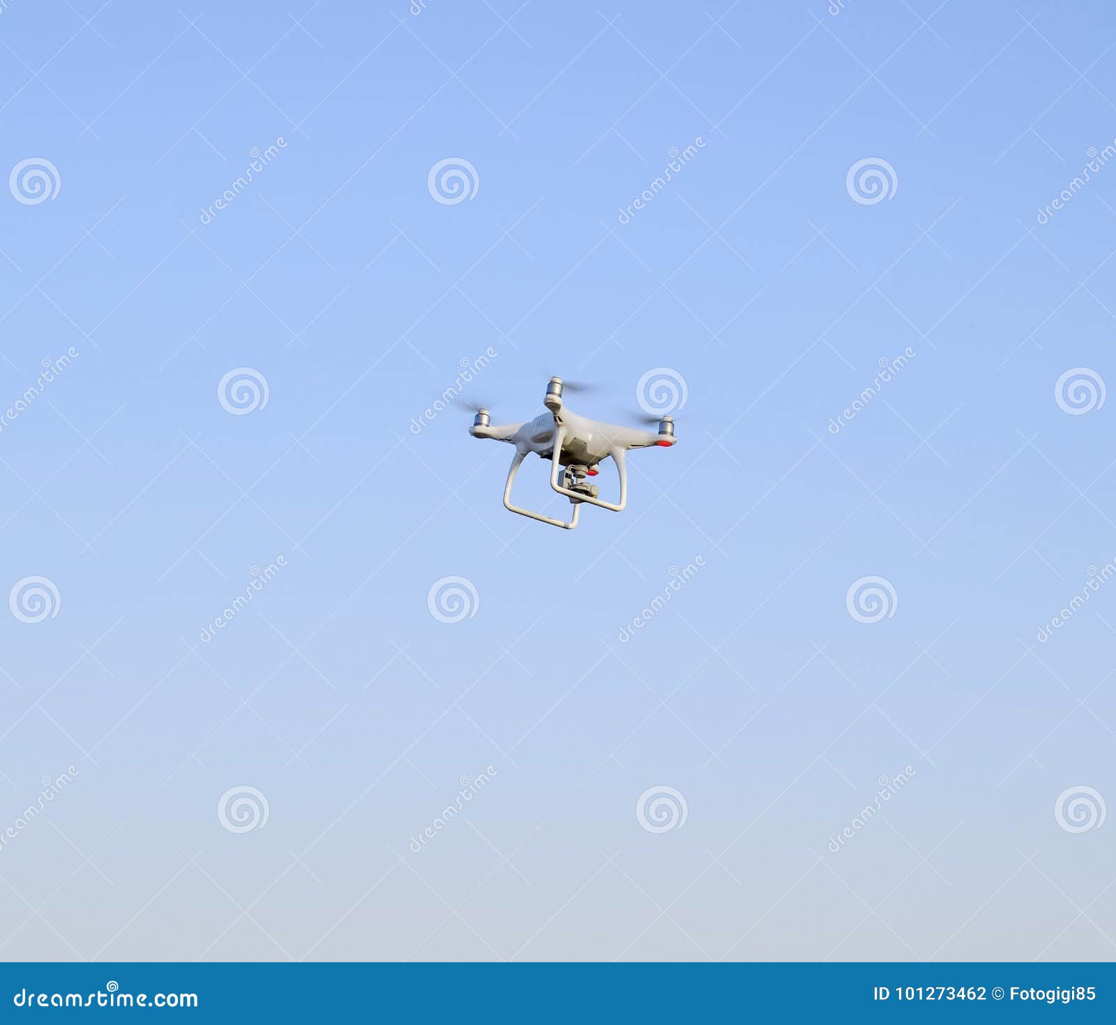 White Drone Against the Blue Evening Sky. Multicopter Flight. Stock ...