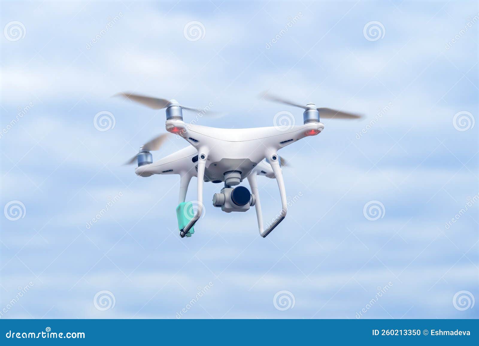 White Drone with Camera in Flight Against Blue Cloudy Sky Stock Photo ...
