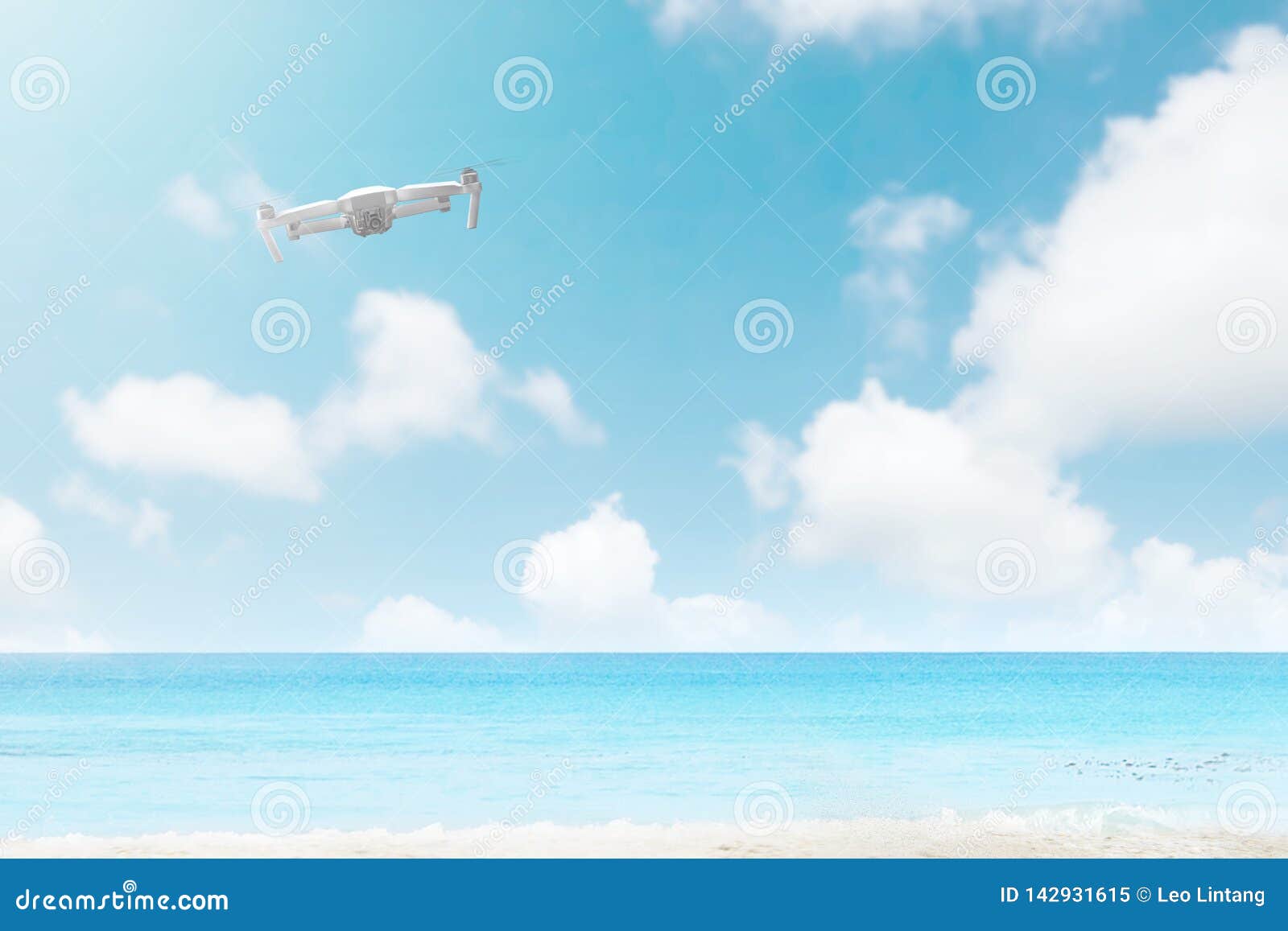 White Drone with Camera Flying Over the Beach with Blue Ocean Stock ...