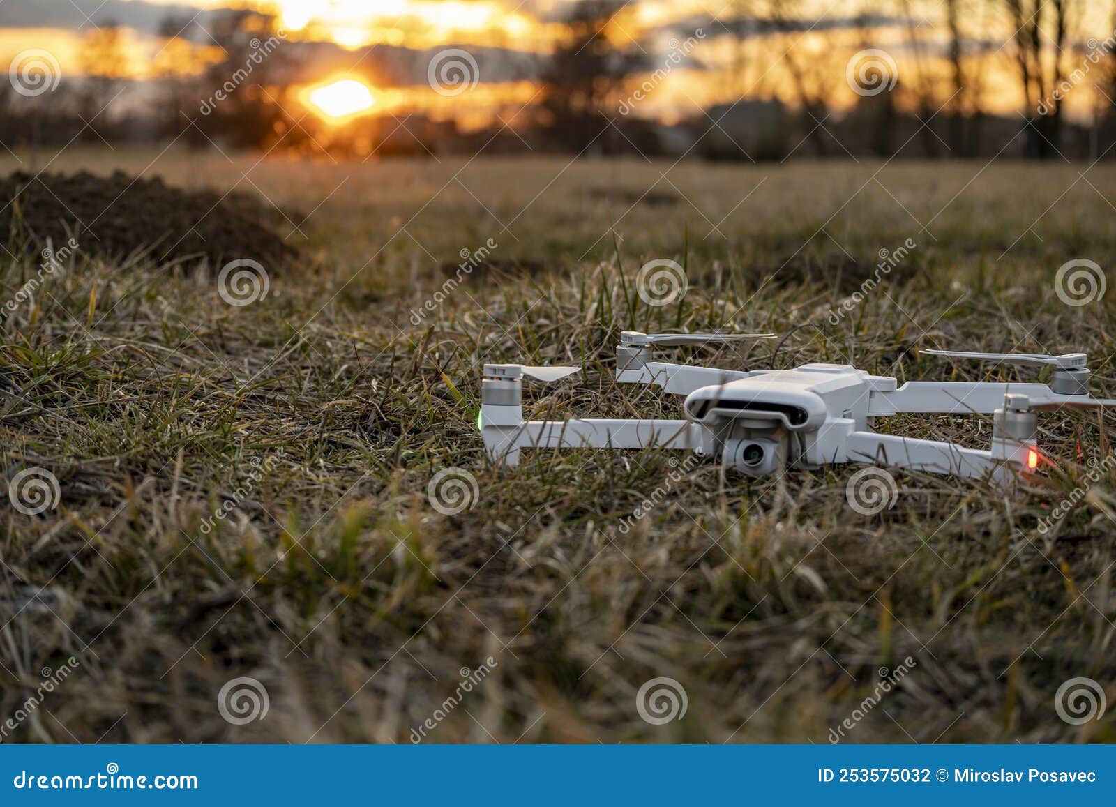 White Drone Lying in the Grass on the Meadow during Sunset, Ready To ...