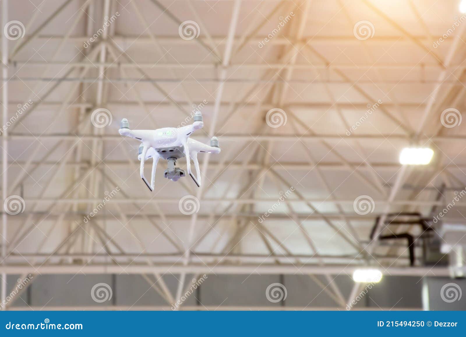 White Drone in Motion Flying from the Ceiling Inside the Building Stock ...