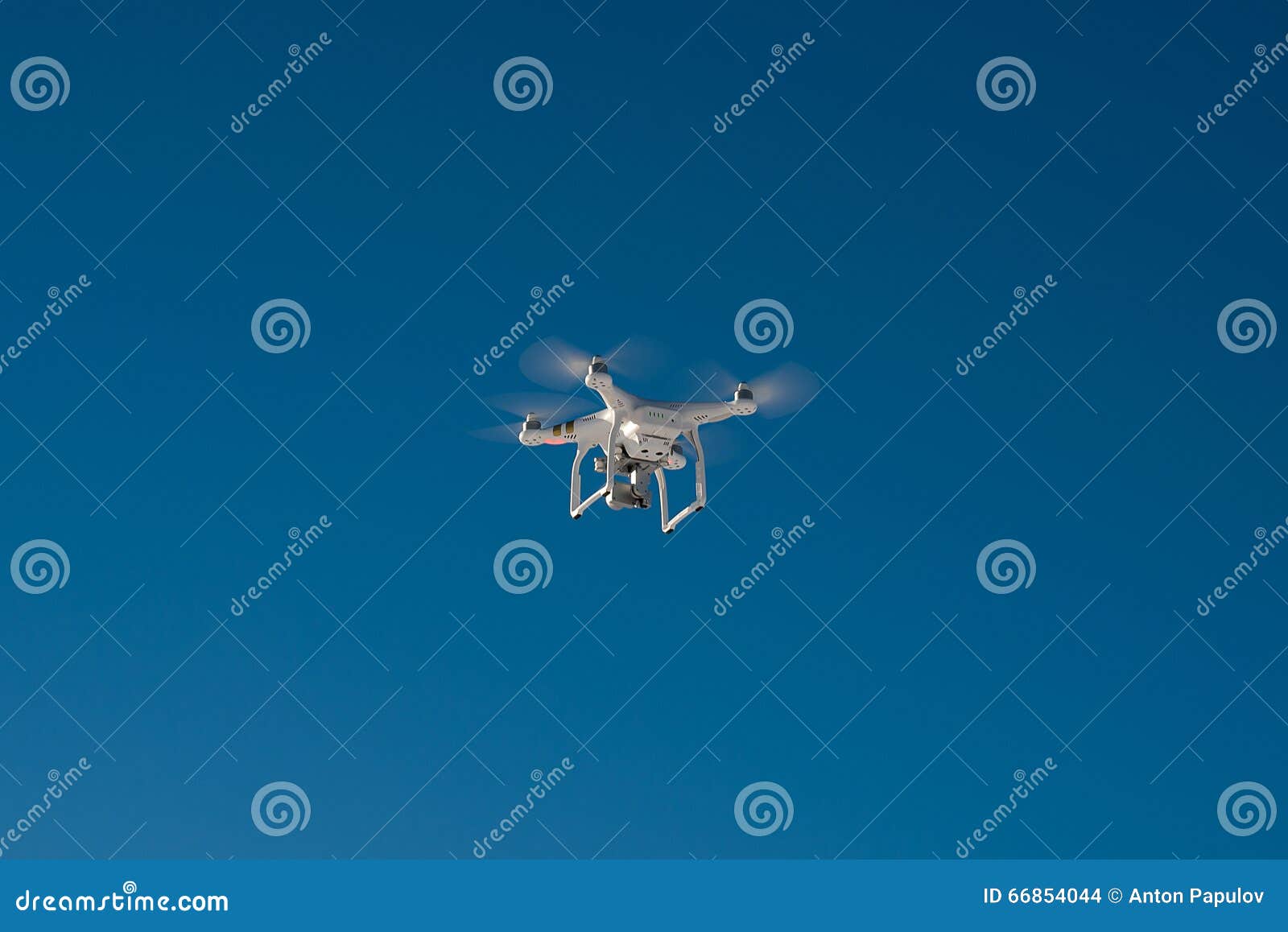 White Drone Quad Copter with Flying in the Blue Sky Stock Photo - Image ...