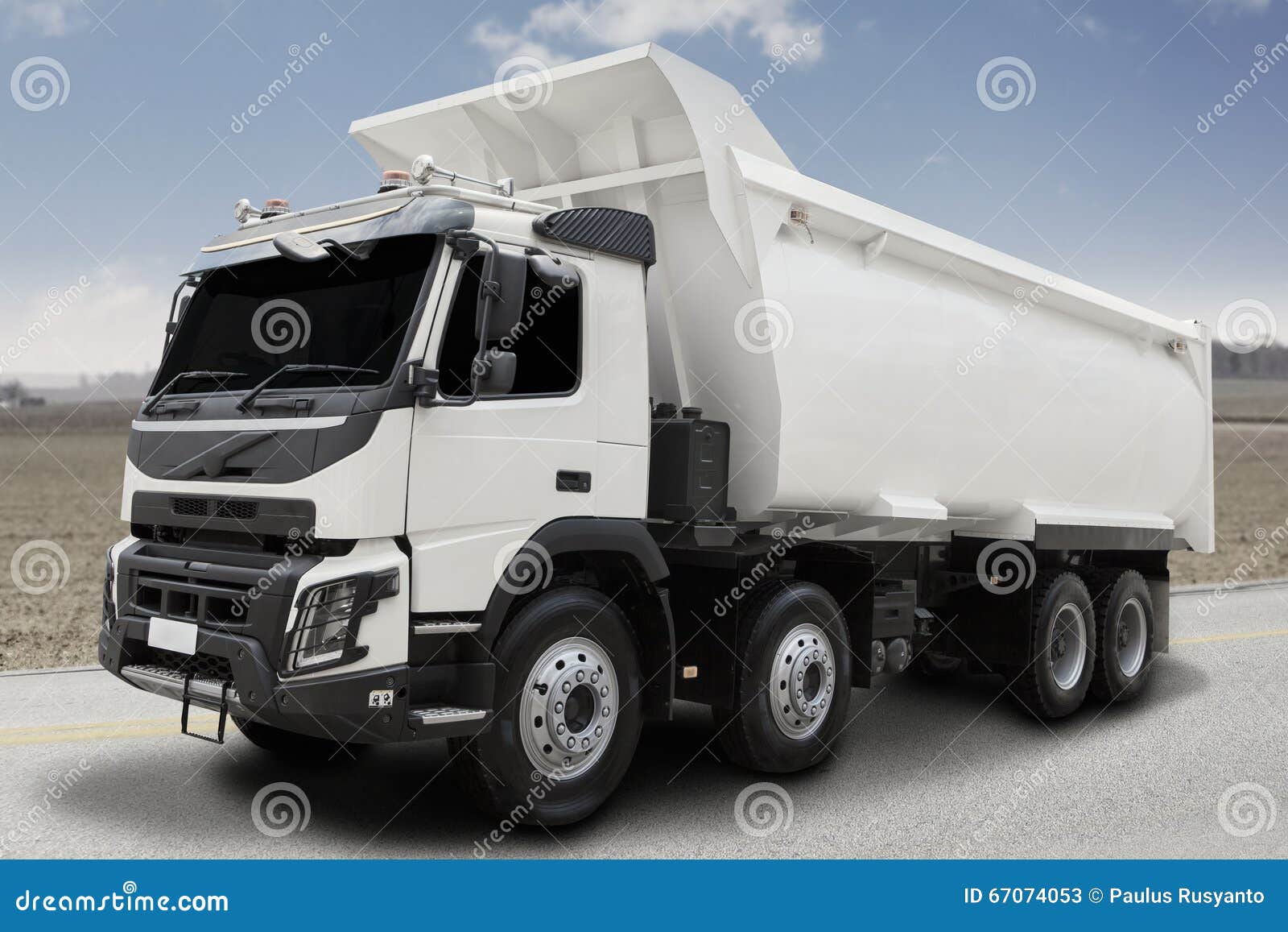 A White Dump Truck, Lorry Full Of Stones In A Sand Quarry, Transporting ...