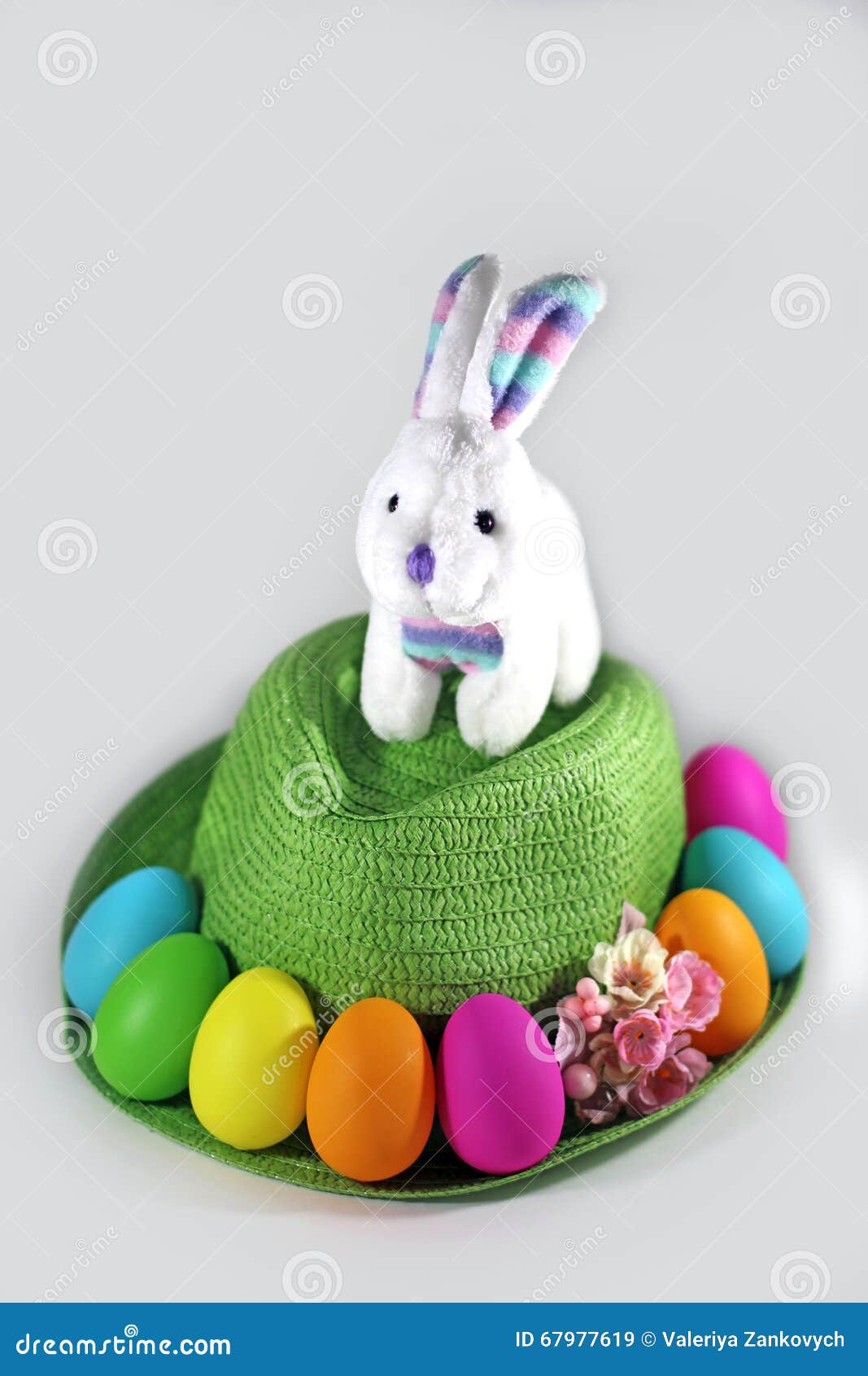 White Easter Bunny Rabbit on a Green Straw Hat with Easter Colorful ...