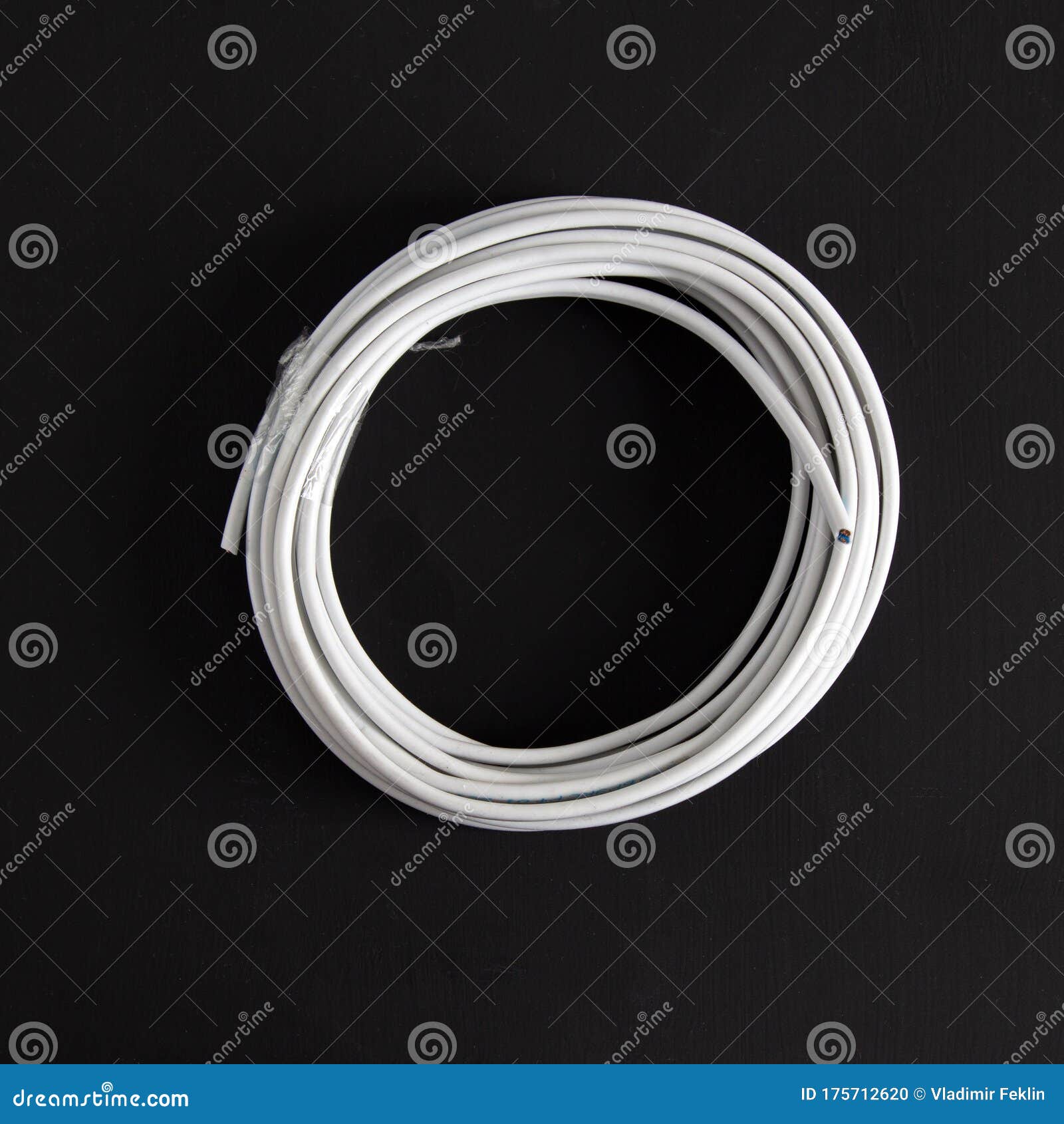 White Electric Cable Rolled into a Circle on a Black Background Stock ...