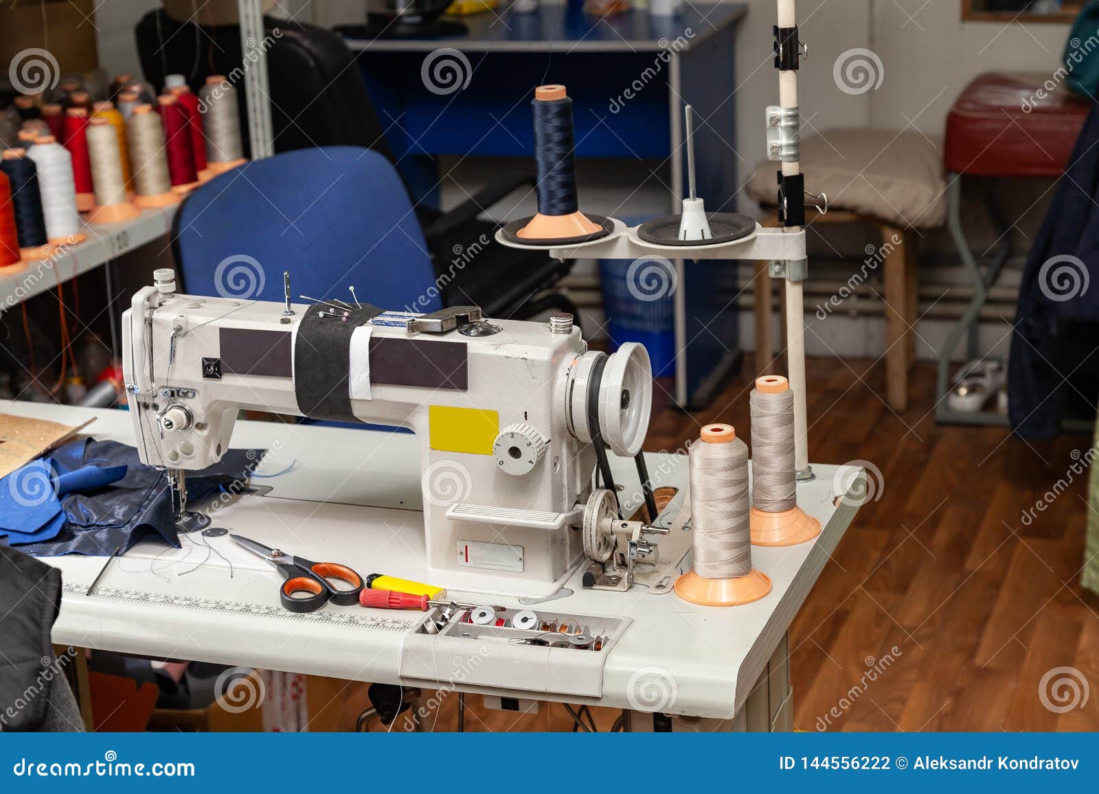 White Electric Industrial Sewing Machine in a Workshop for Sewing and ...