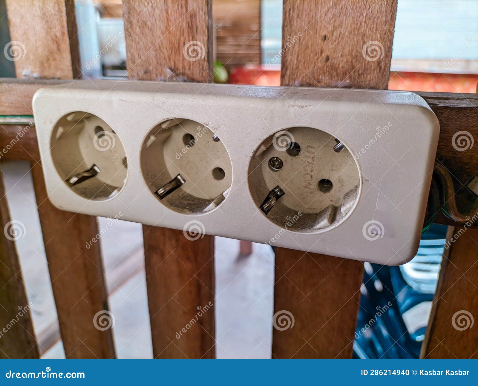 White Electric Socket on Wooden Wall. Power Plug with Wire in Socket ...