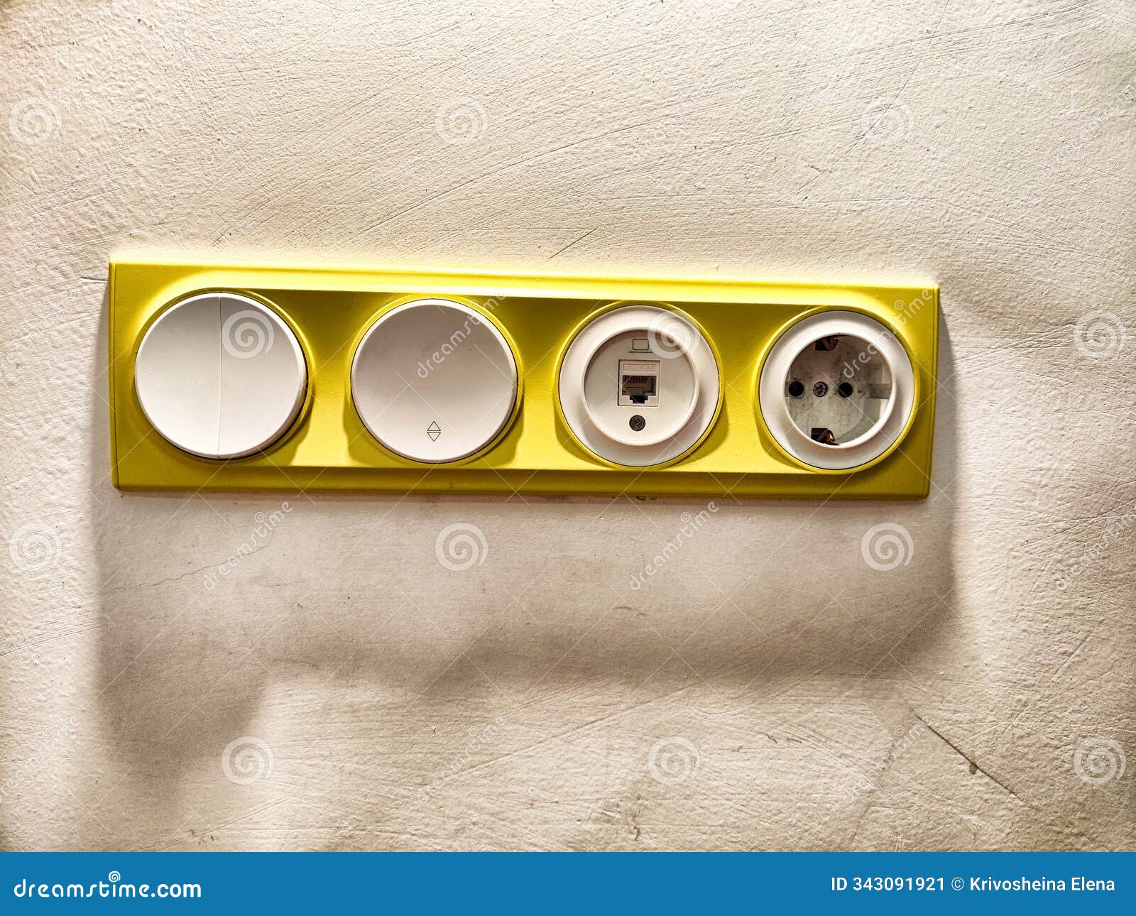 A White Electrical Outlet and Light Switch Mounted on a Textured Wall ...