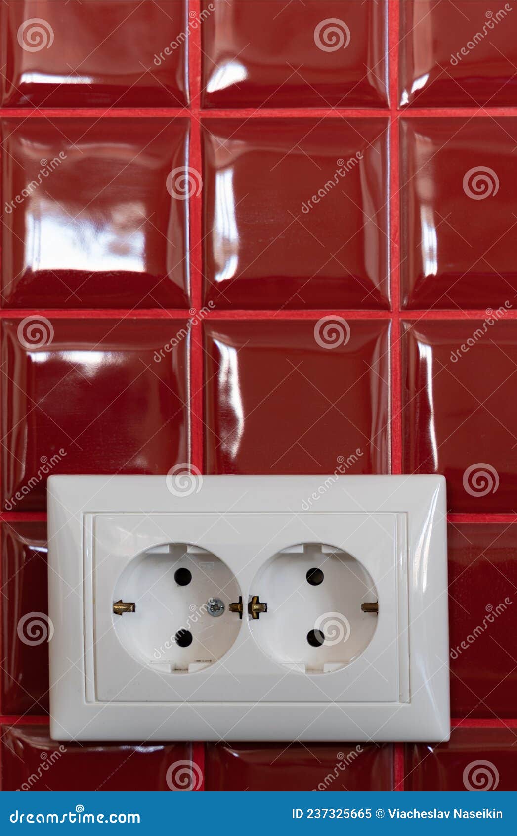 White Electrical Outlet on a Red Ceramic Tile Wall with Conductive ...